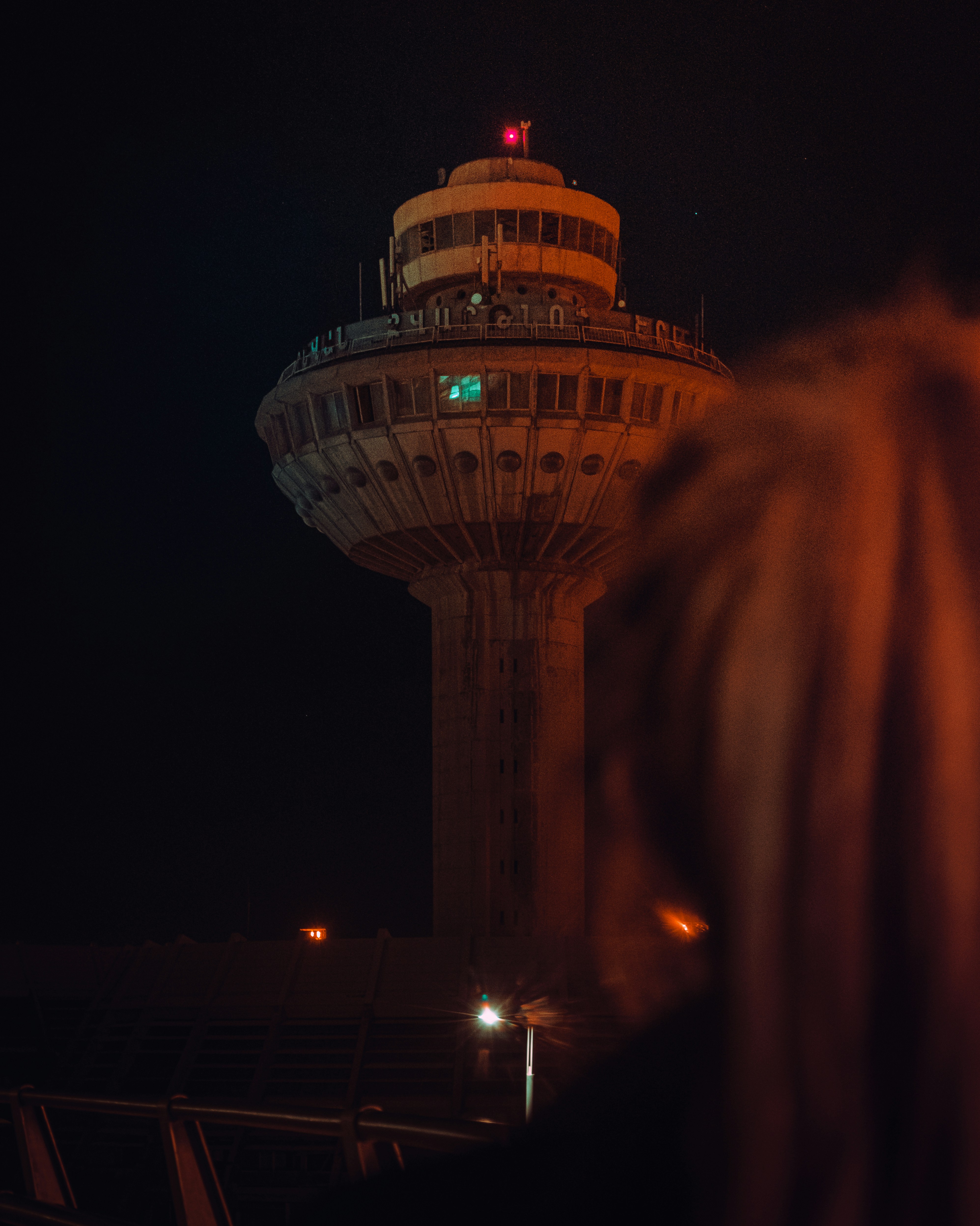 A large tower with lights at night photo – Free Looking far Image on ...