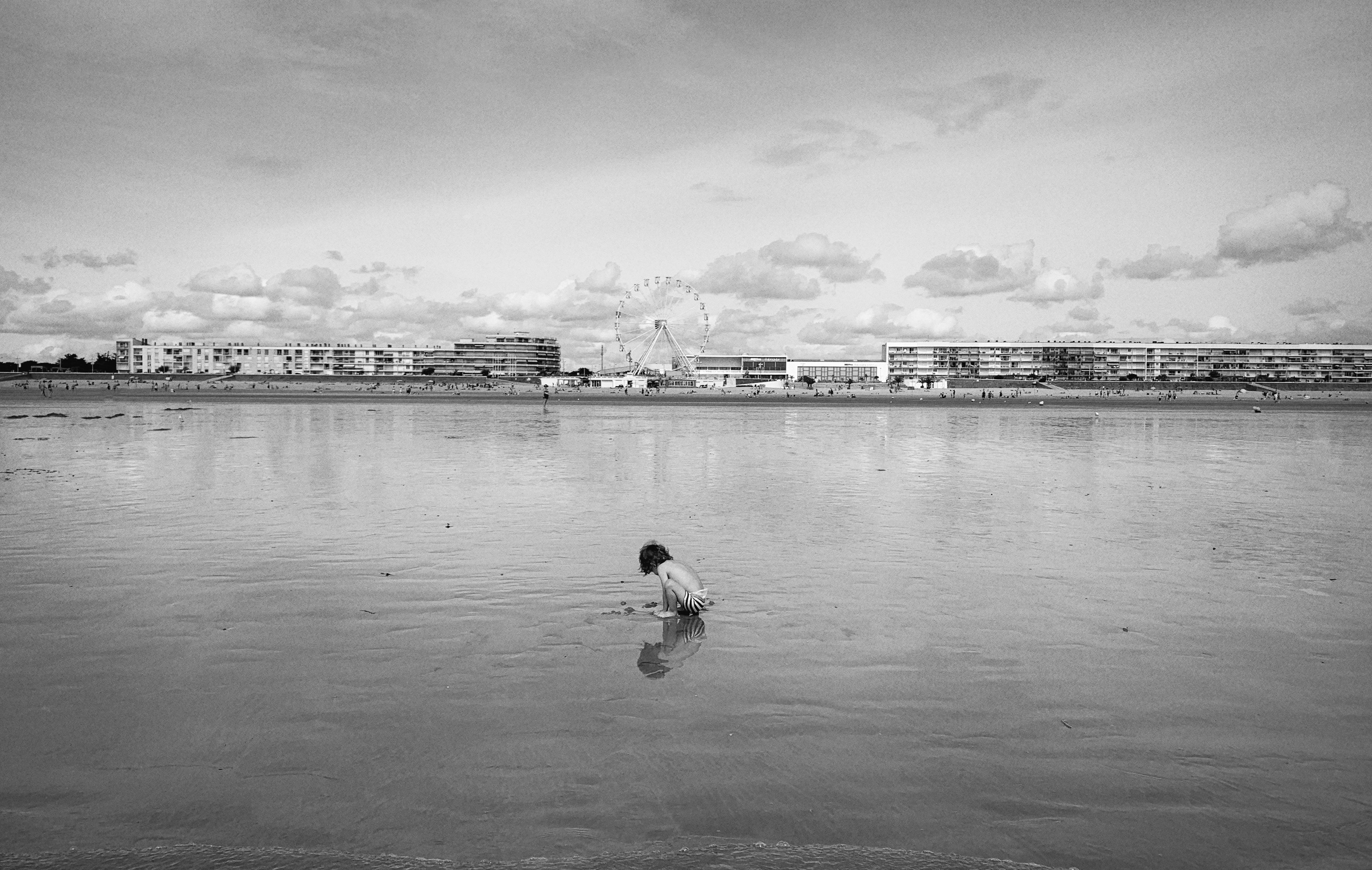 Solitary Figure in a Silvery Tide: Reflections by an Urban Shore