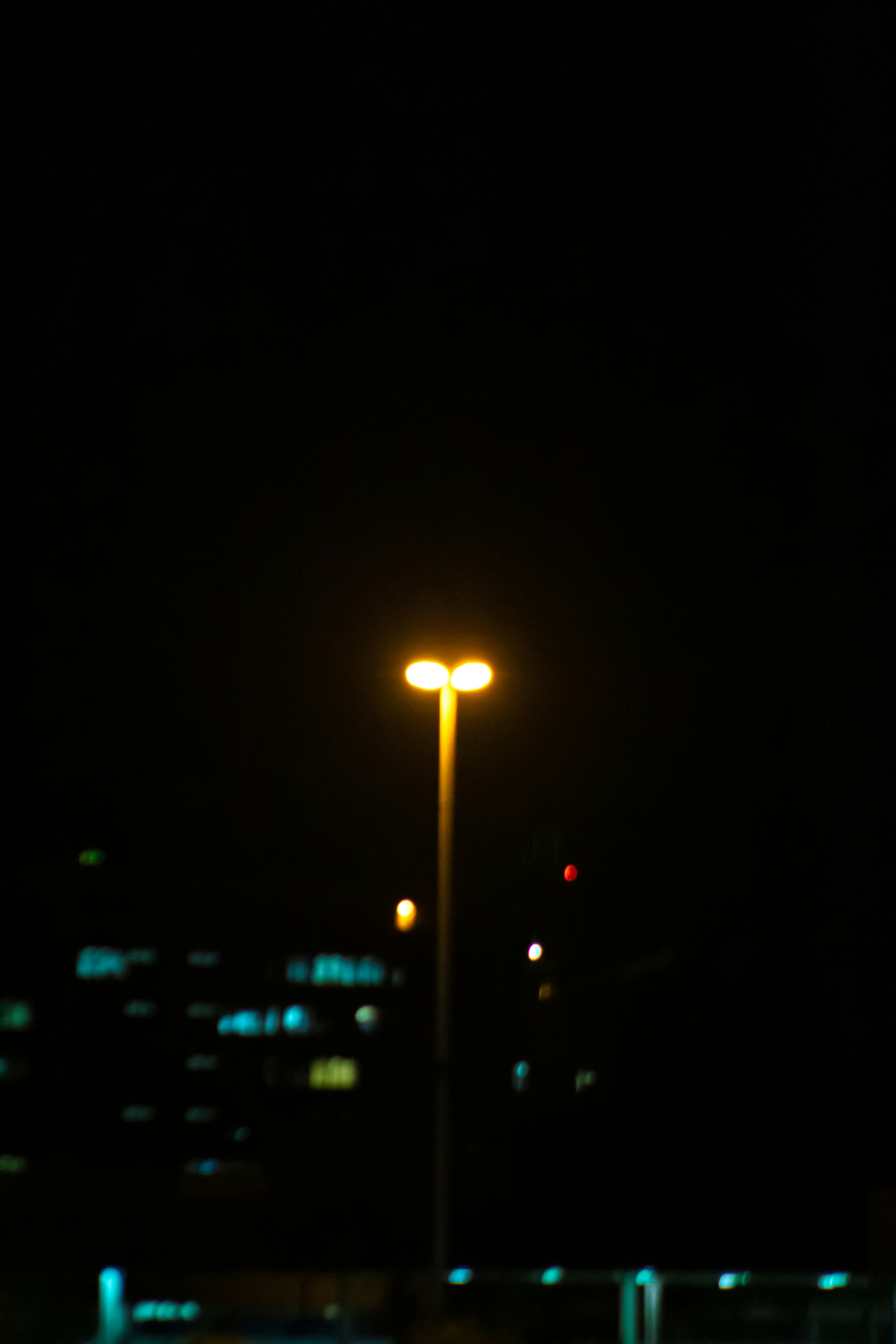 A street light with a city in the background photo – Free Night Image ...