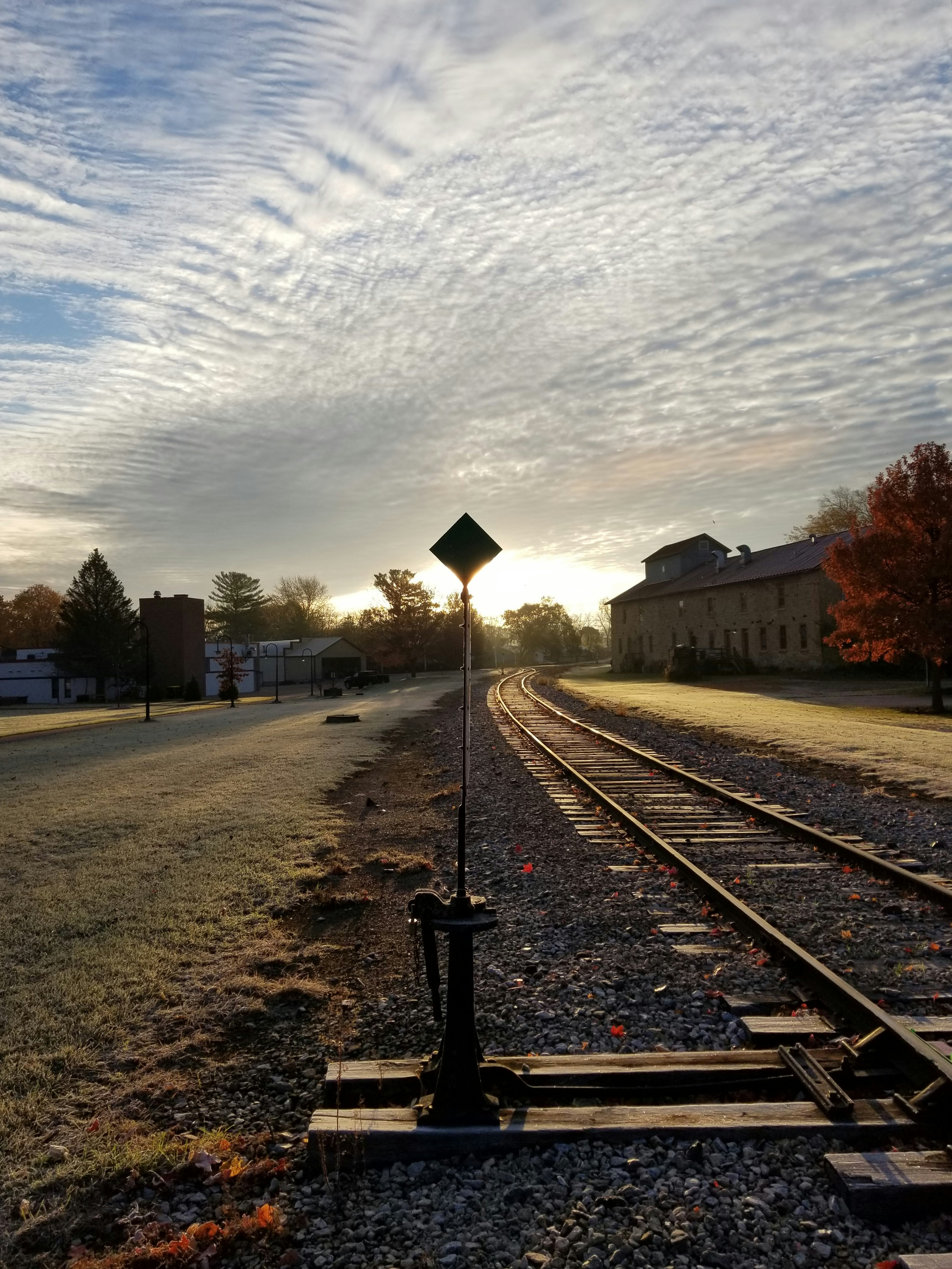 Diamond Sign at Dusk: Rails Vanish into a Quiet Horizon