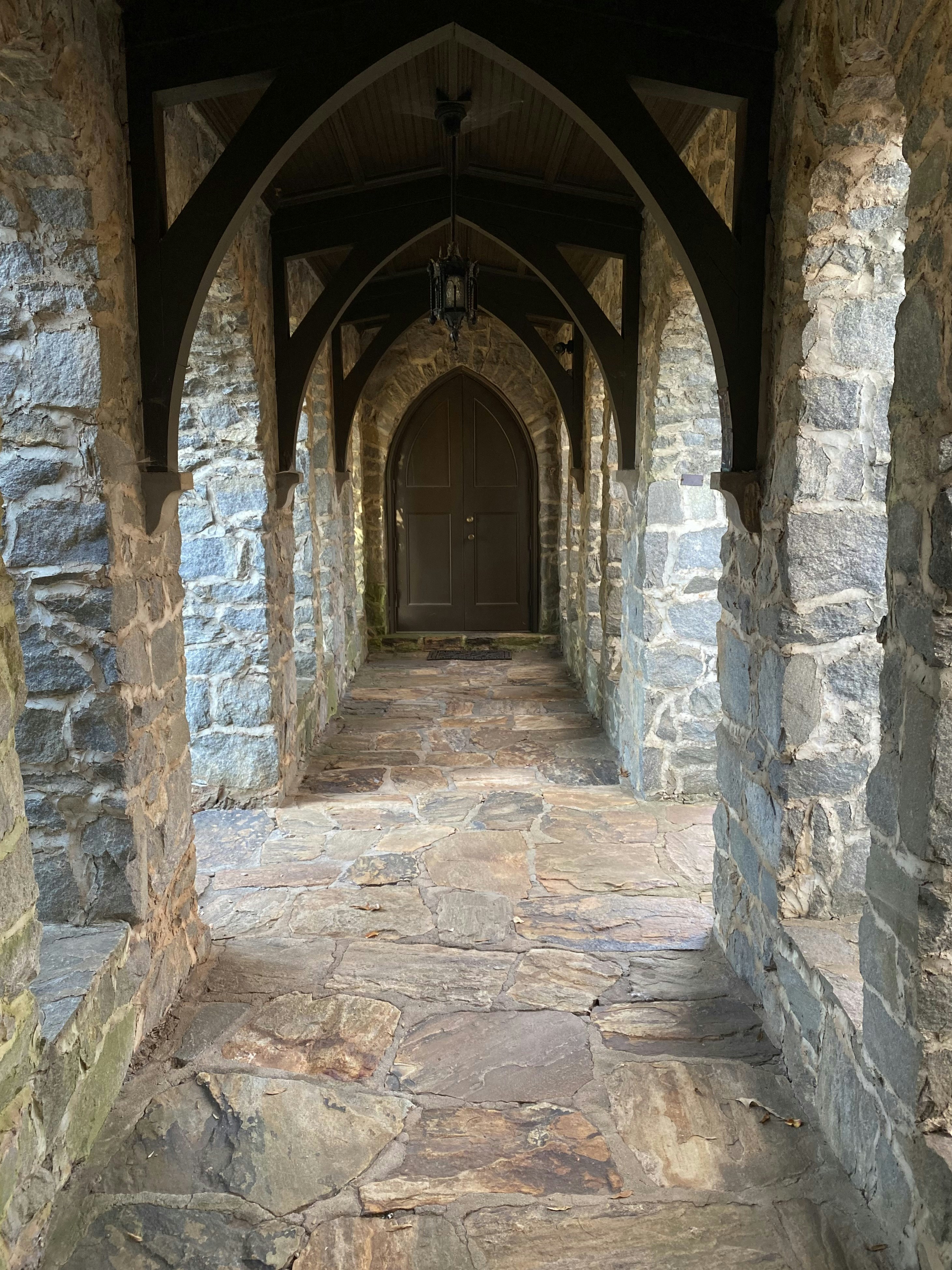 a stone walkway with a door