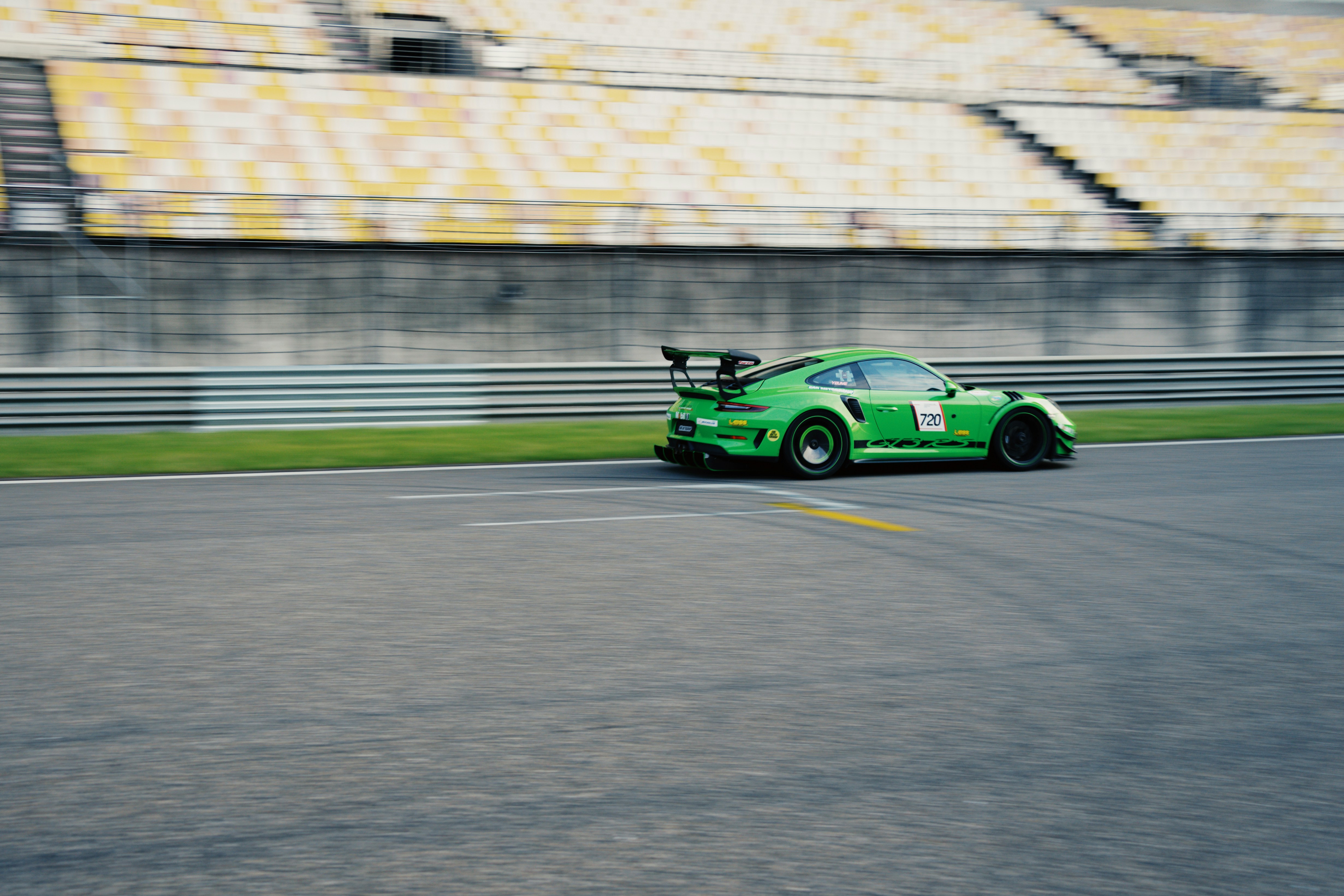 a green race car on a track