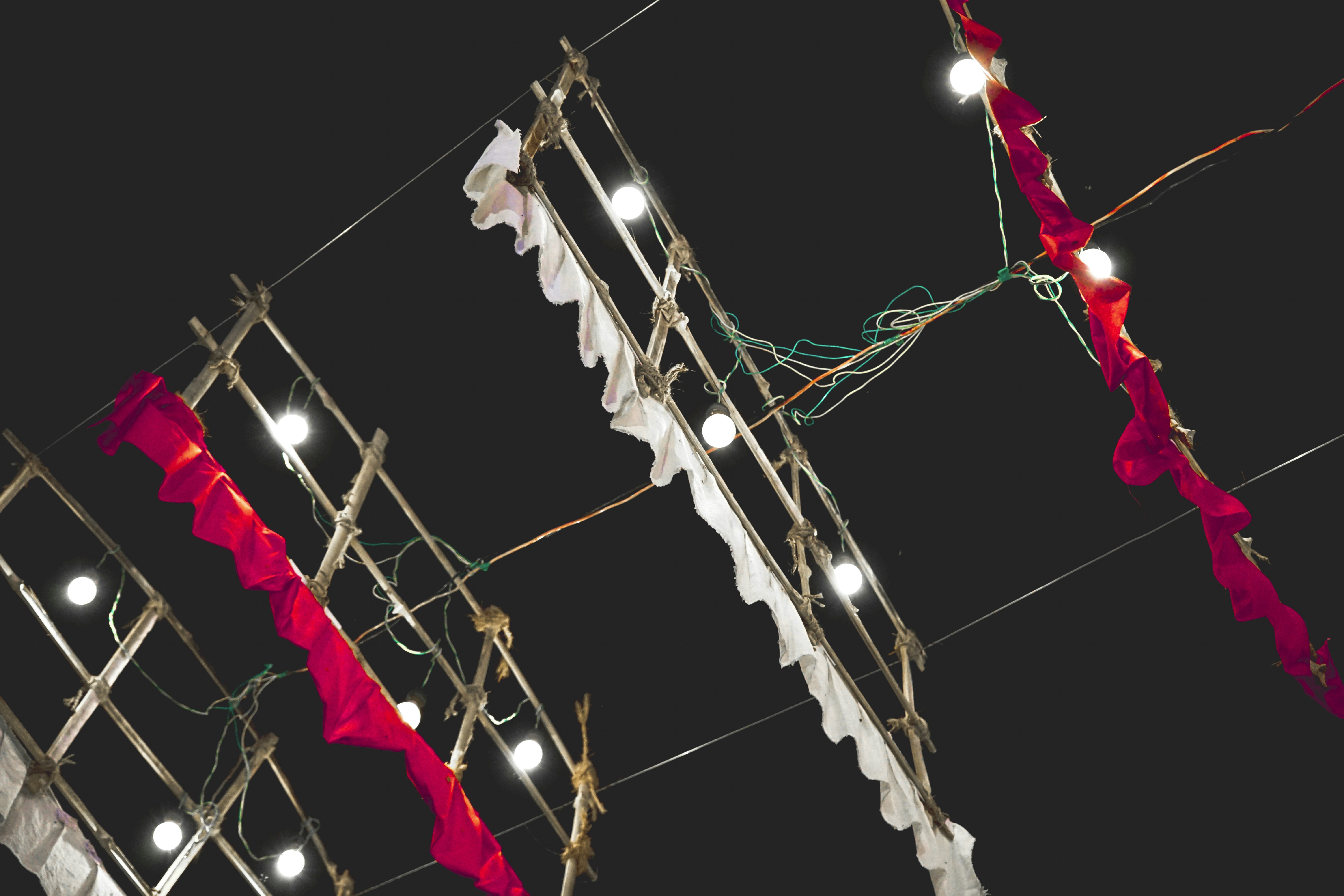 Strings of Nightfall: Colored Ribbons Draped under Dim Lights