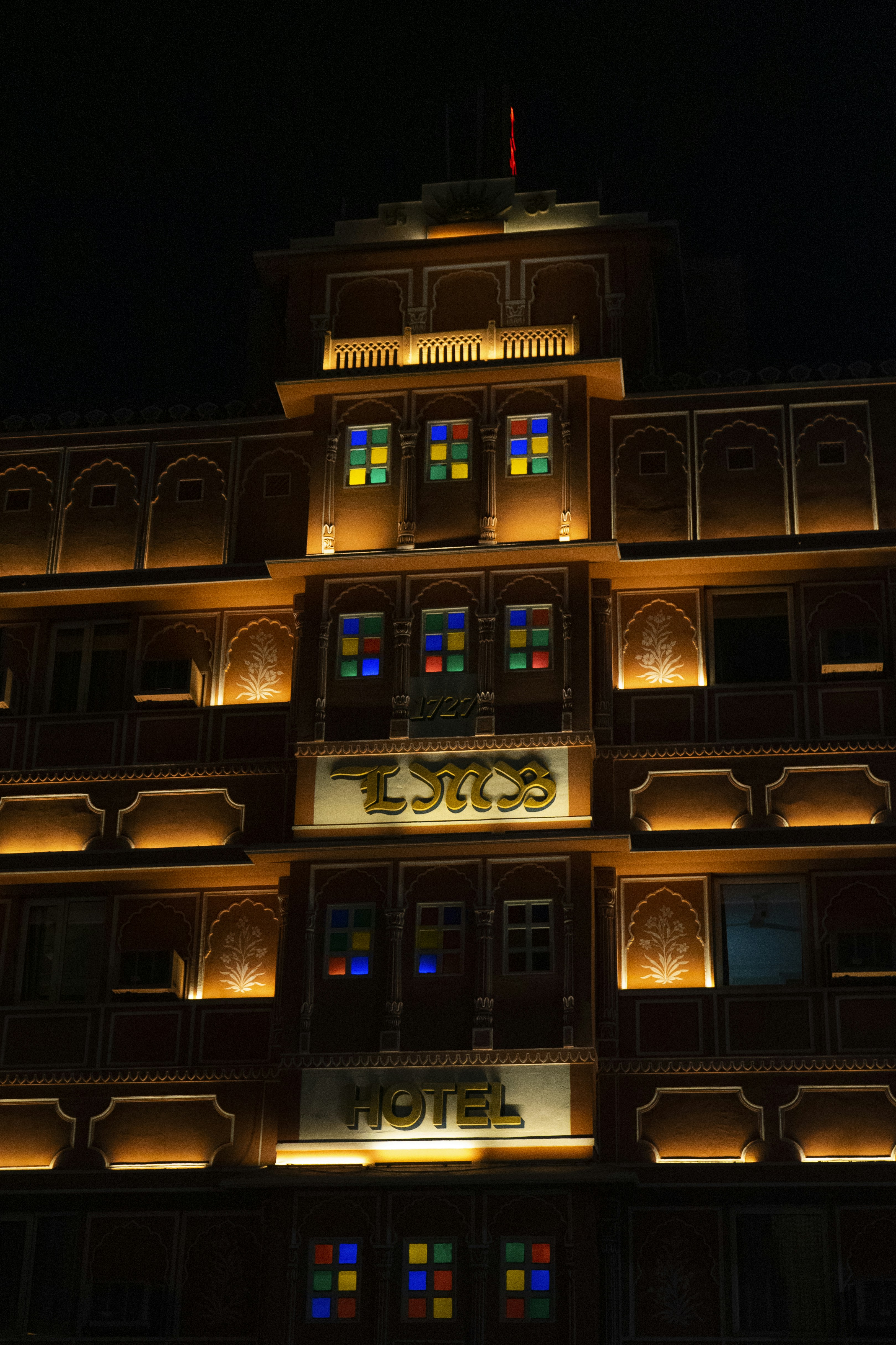 Golden Facade of the Esquire Hotel at Night