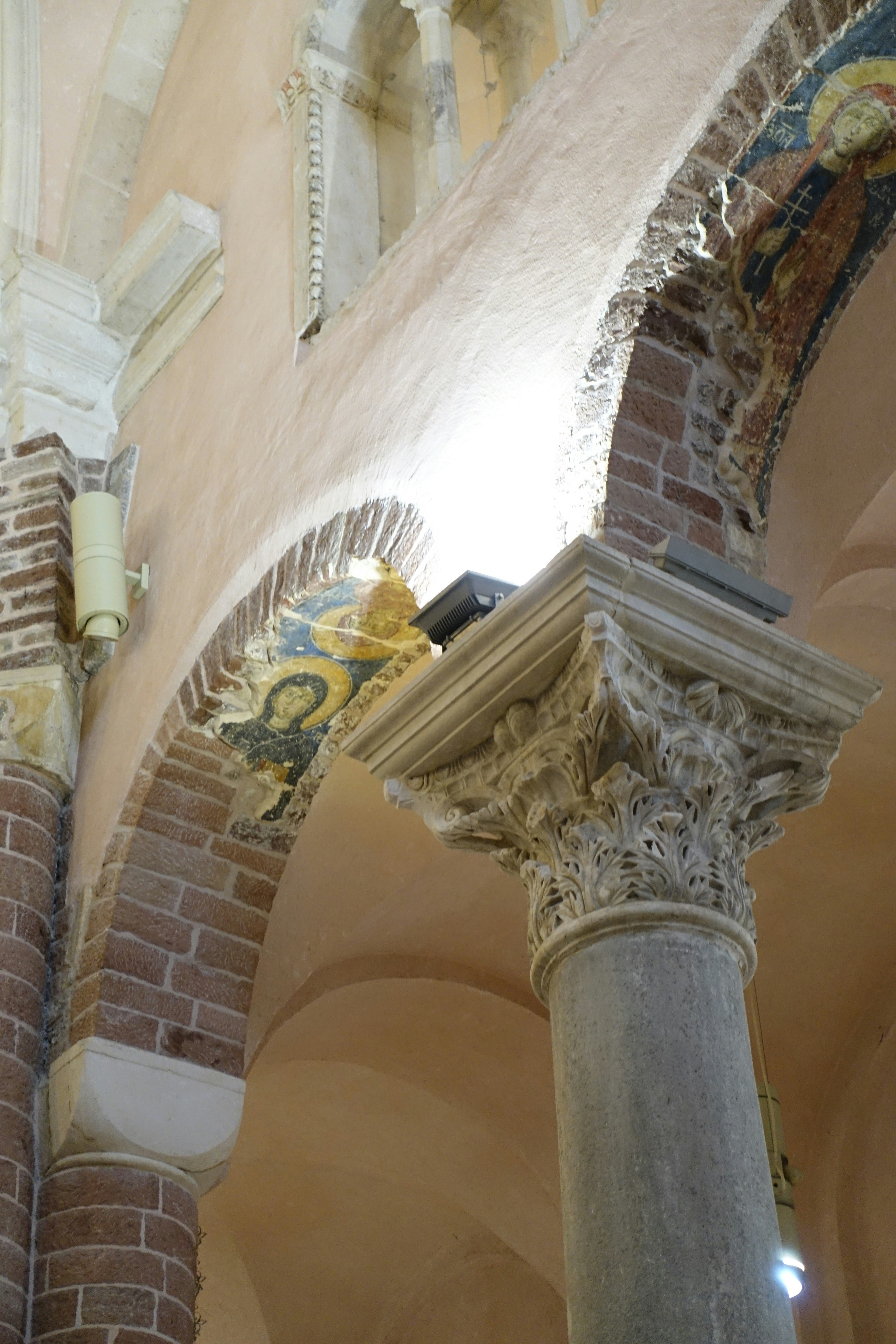 Sunlit Corinthian Capital Framing an Arcaded Mosaic Hall
