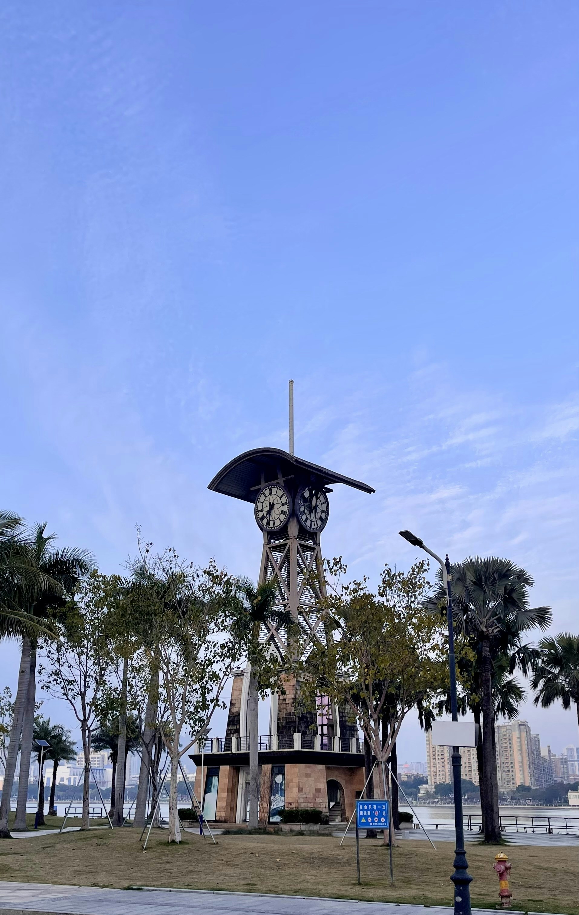 Clock Tower by the Waterfront Under a Clear Sky