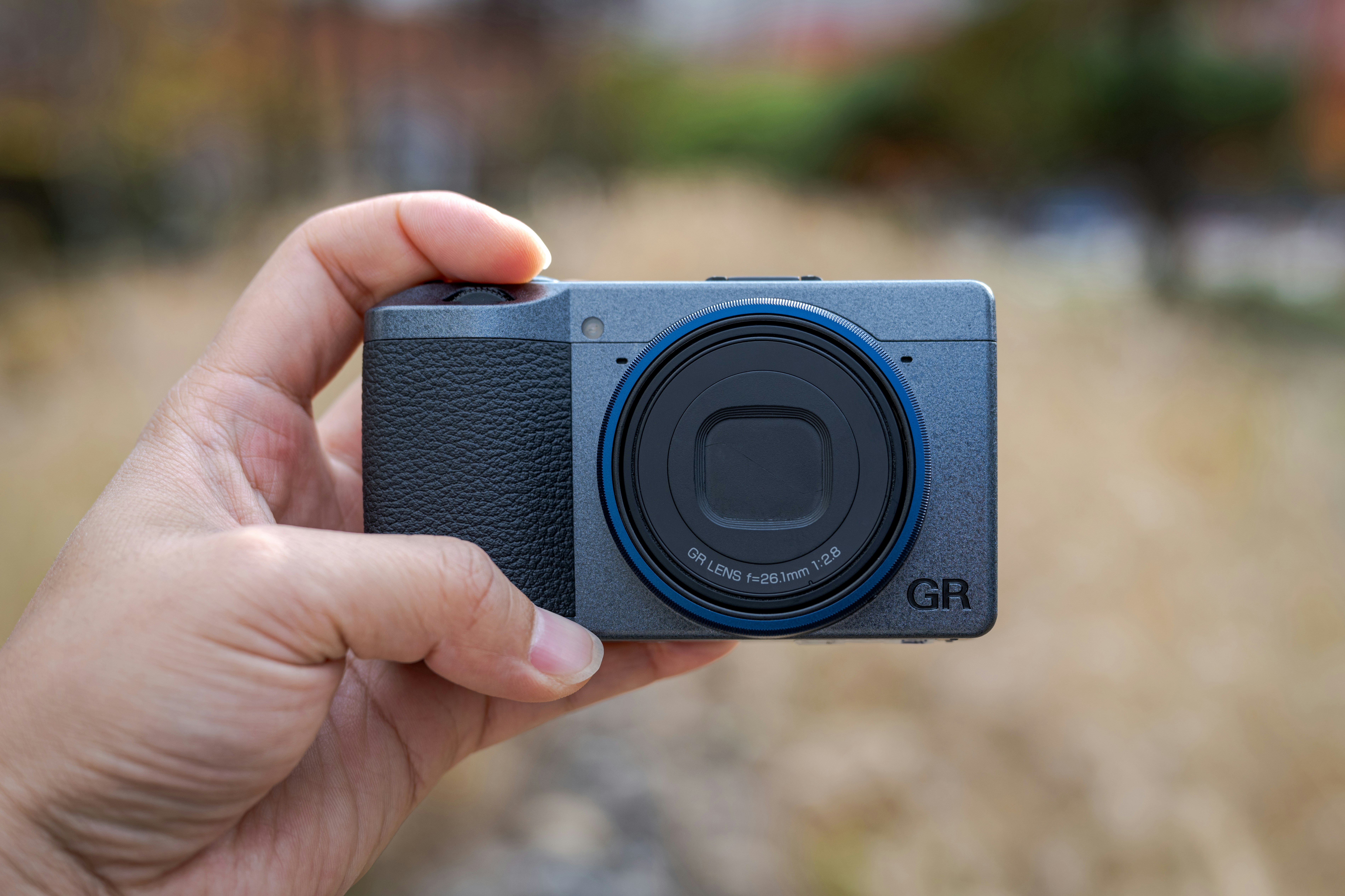 Blue-Ring Ricoh GR: A Compact Handheld Moment of Precision