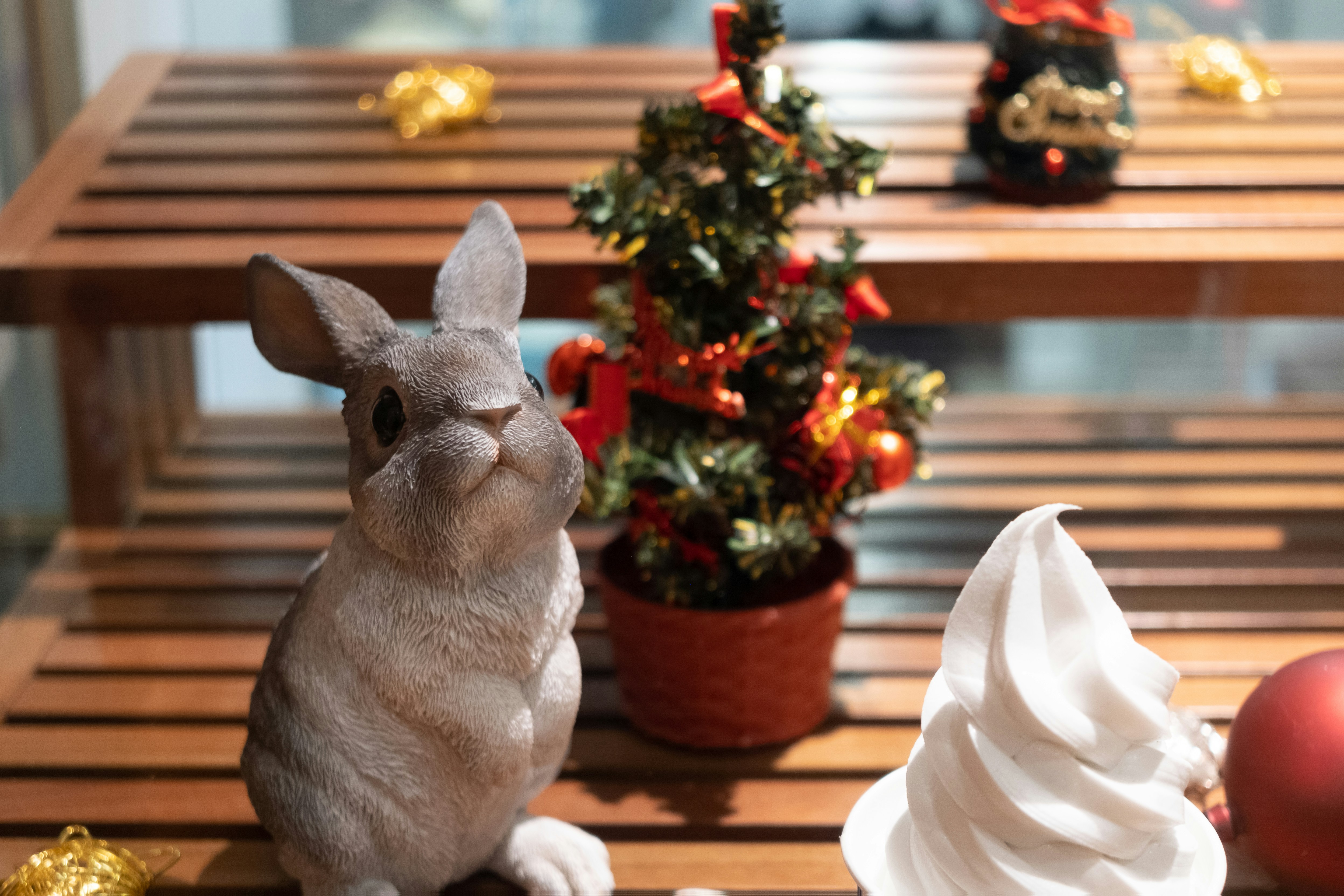 Winter Whimsy on a Slatted Bench: Rabbit, Tree, and Cream
