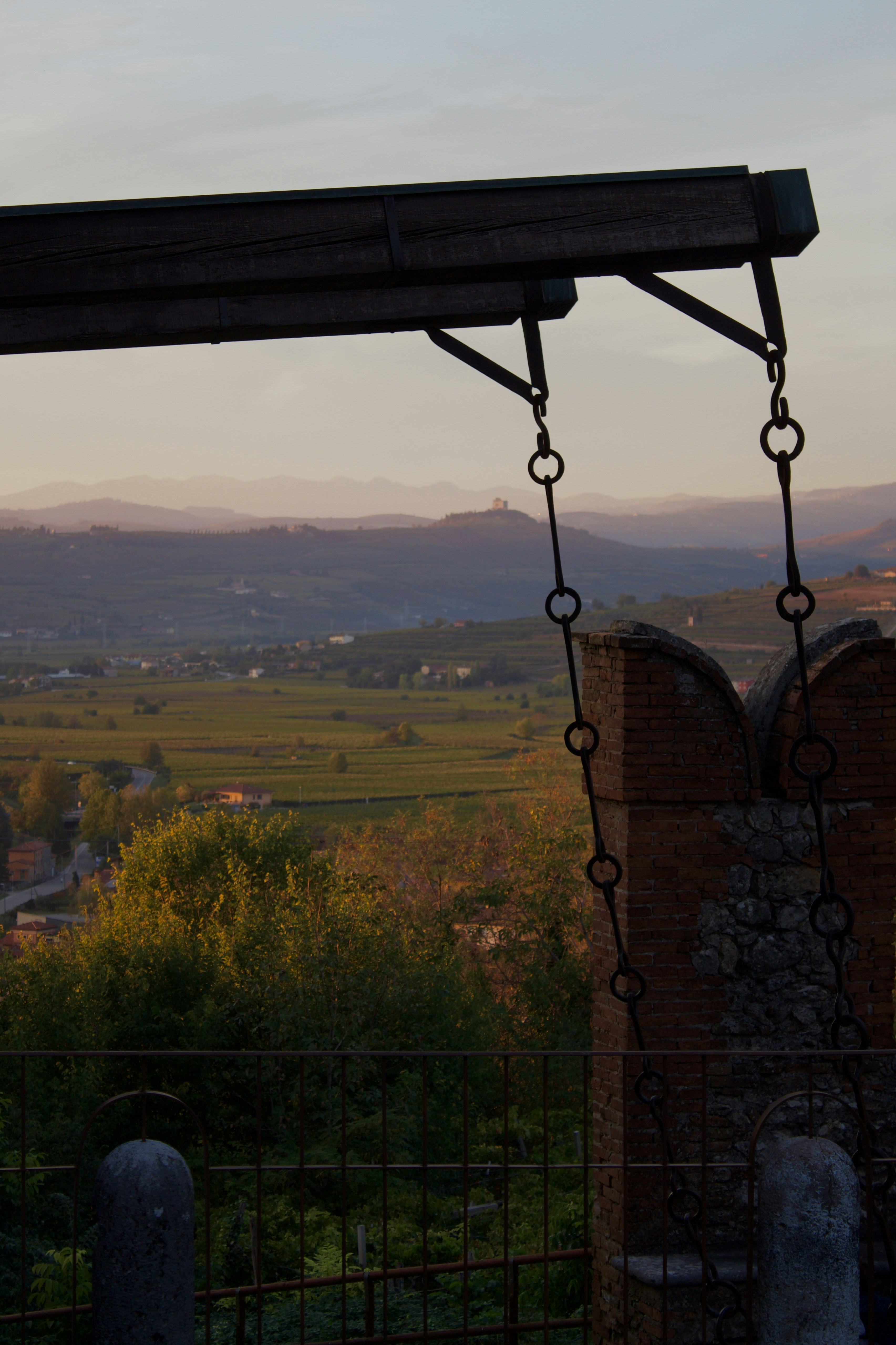Rusted Chains and Golden Hills: A Sunset Over the Walled Terrace