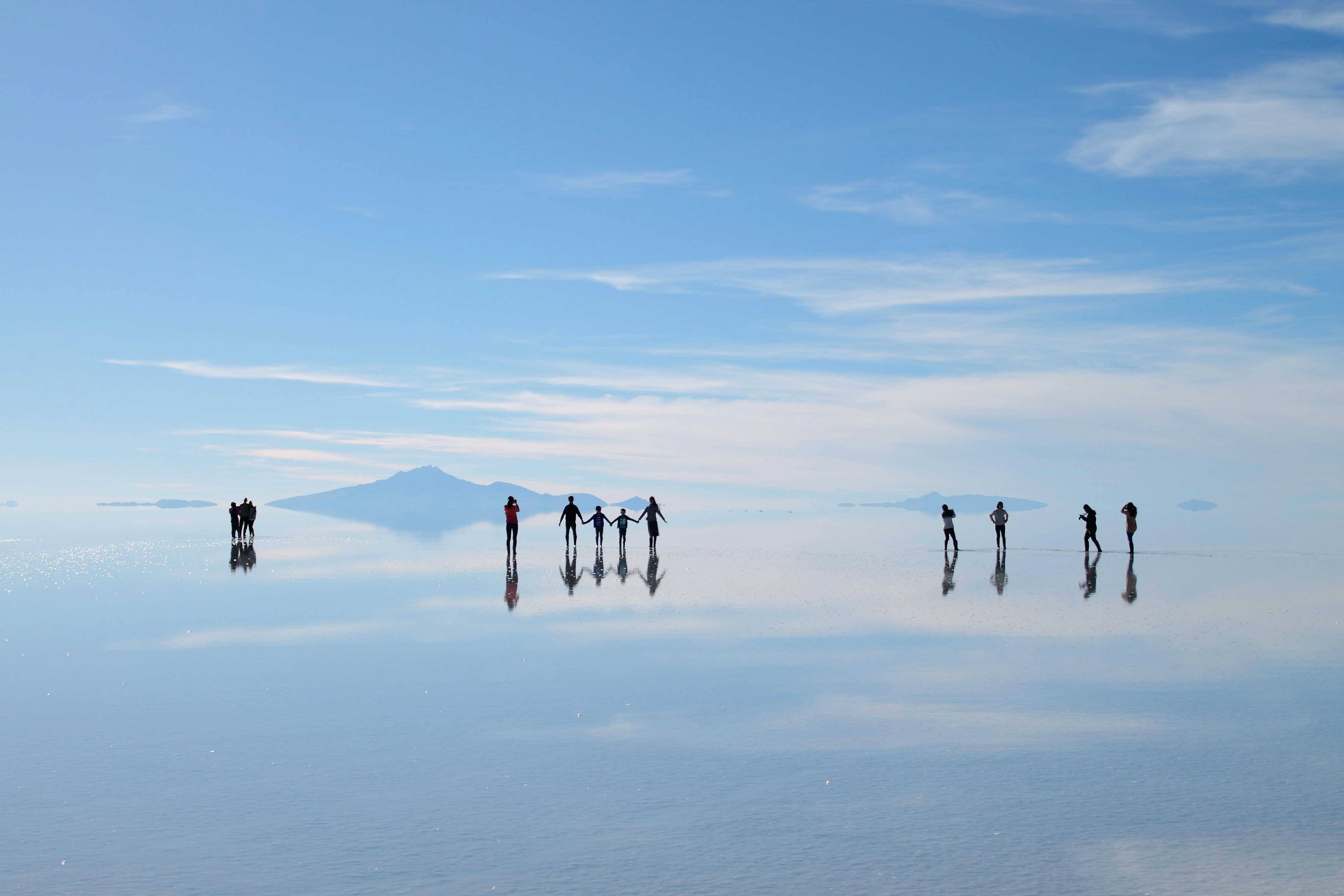 A group of people standing in water photo – Free Salar de uyuni Image ...