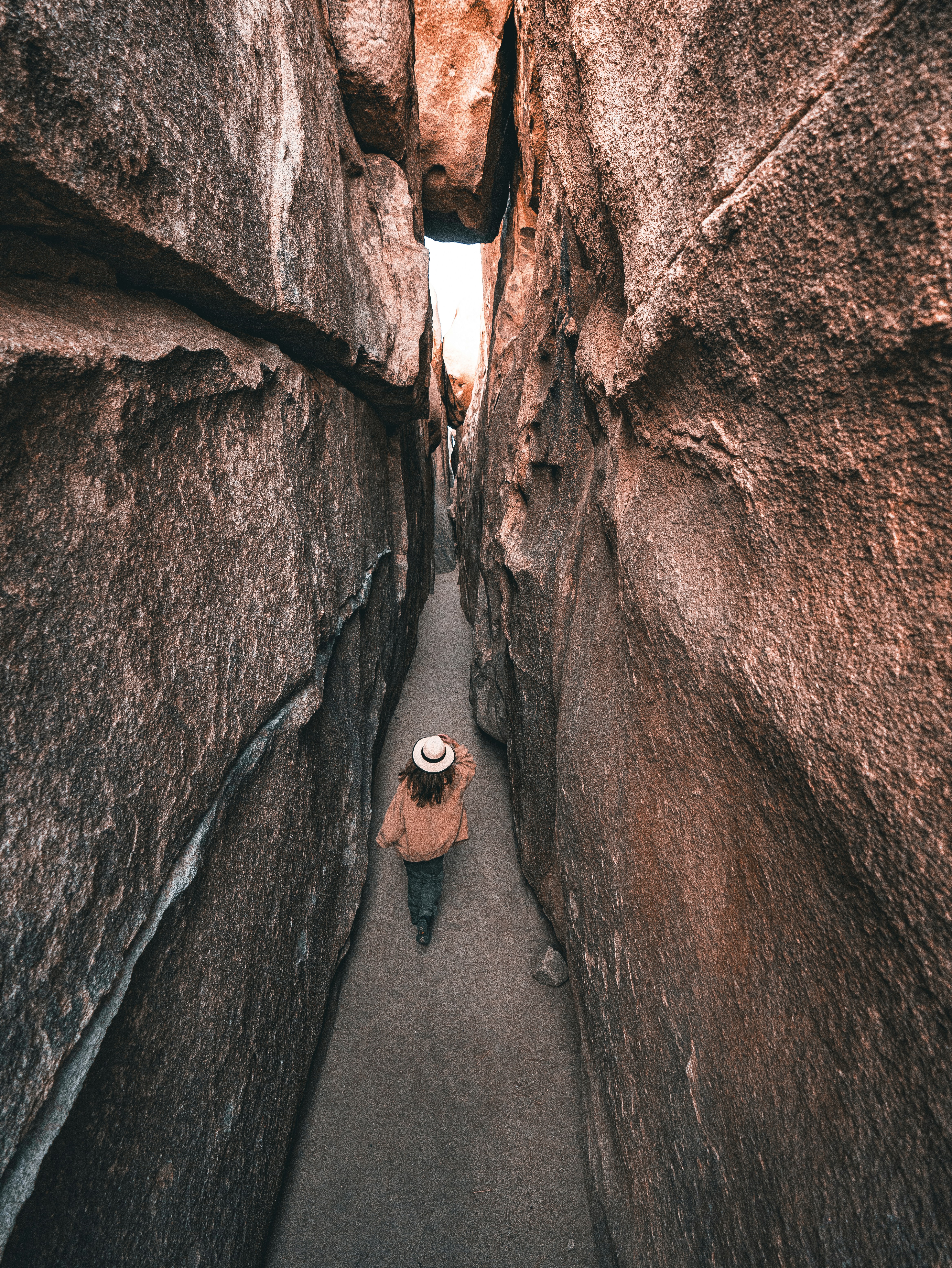 a person standing in a narrow canyon