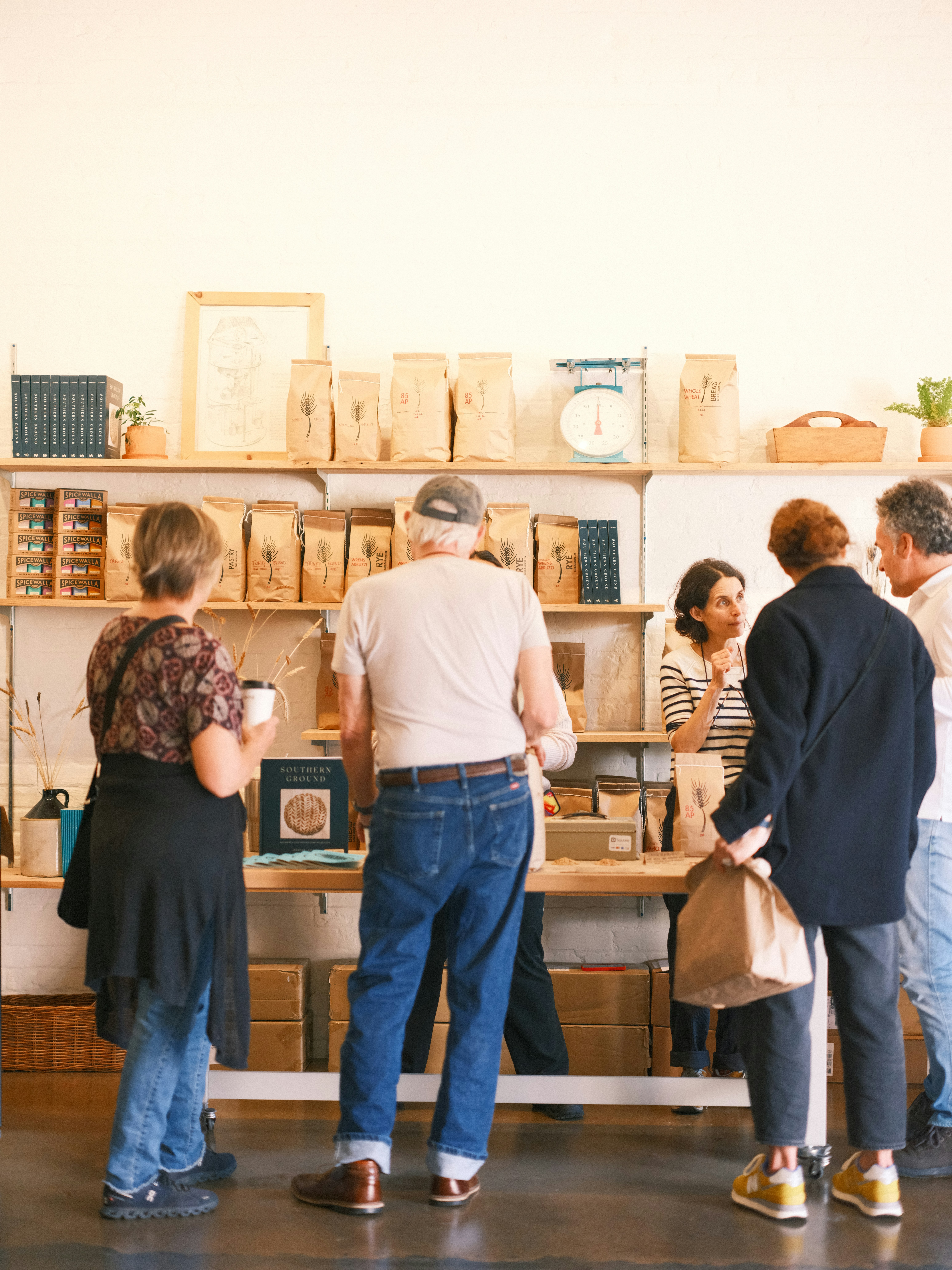 A group of people standing in front of a display of books photo – Free ...