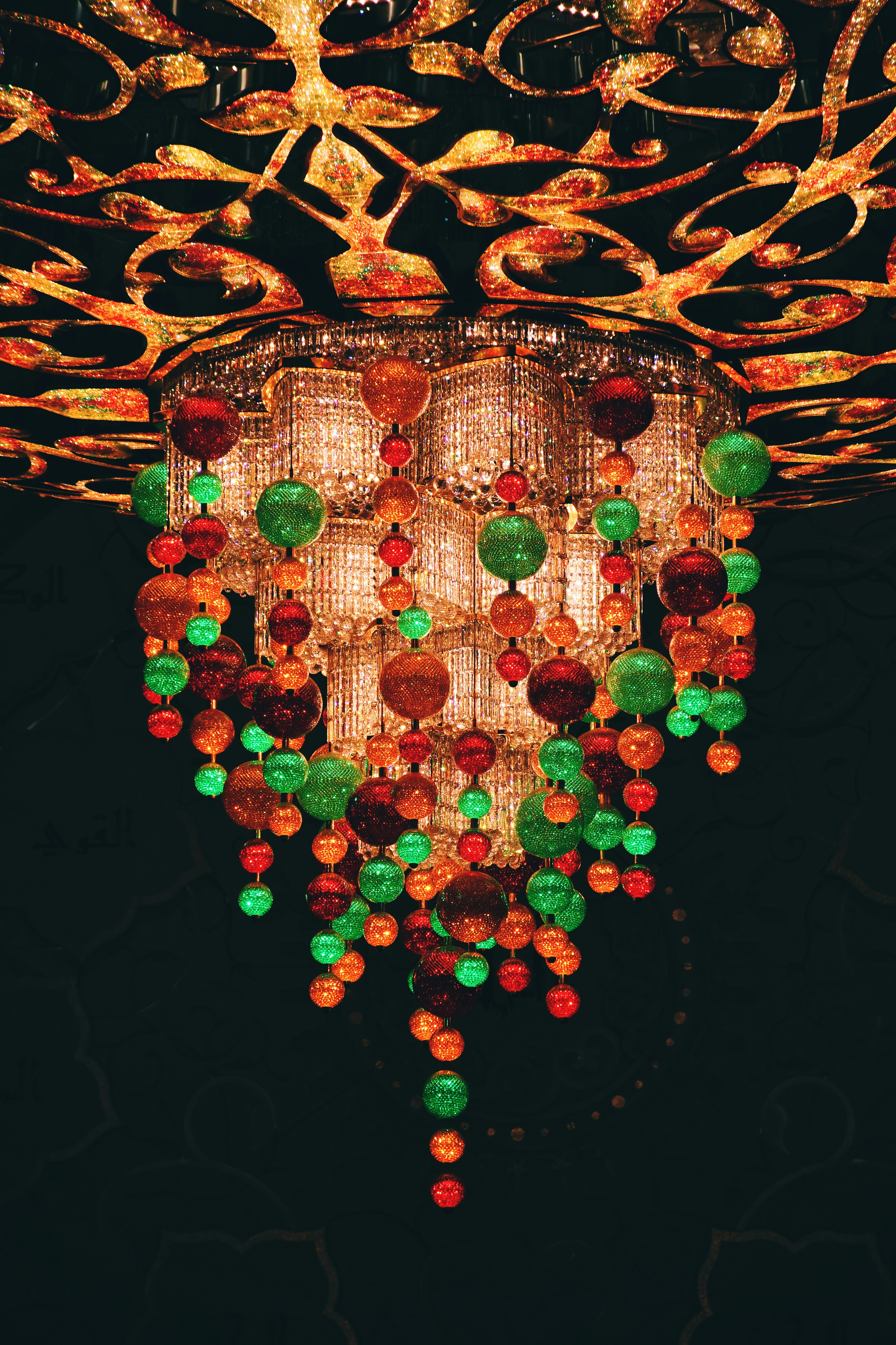 Emerald and Amber Beads Draped from a Crystal Chandelier