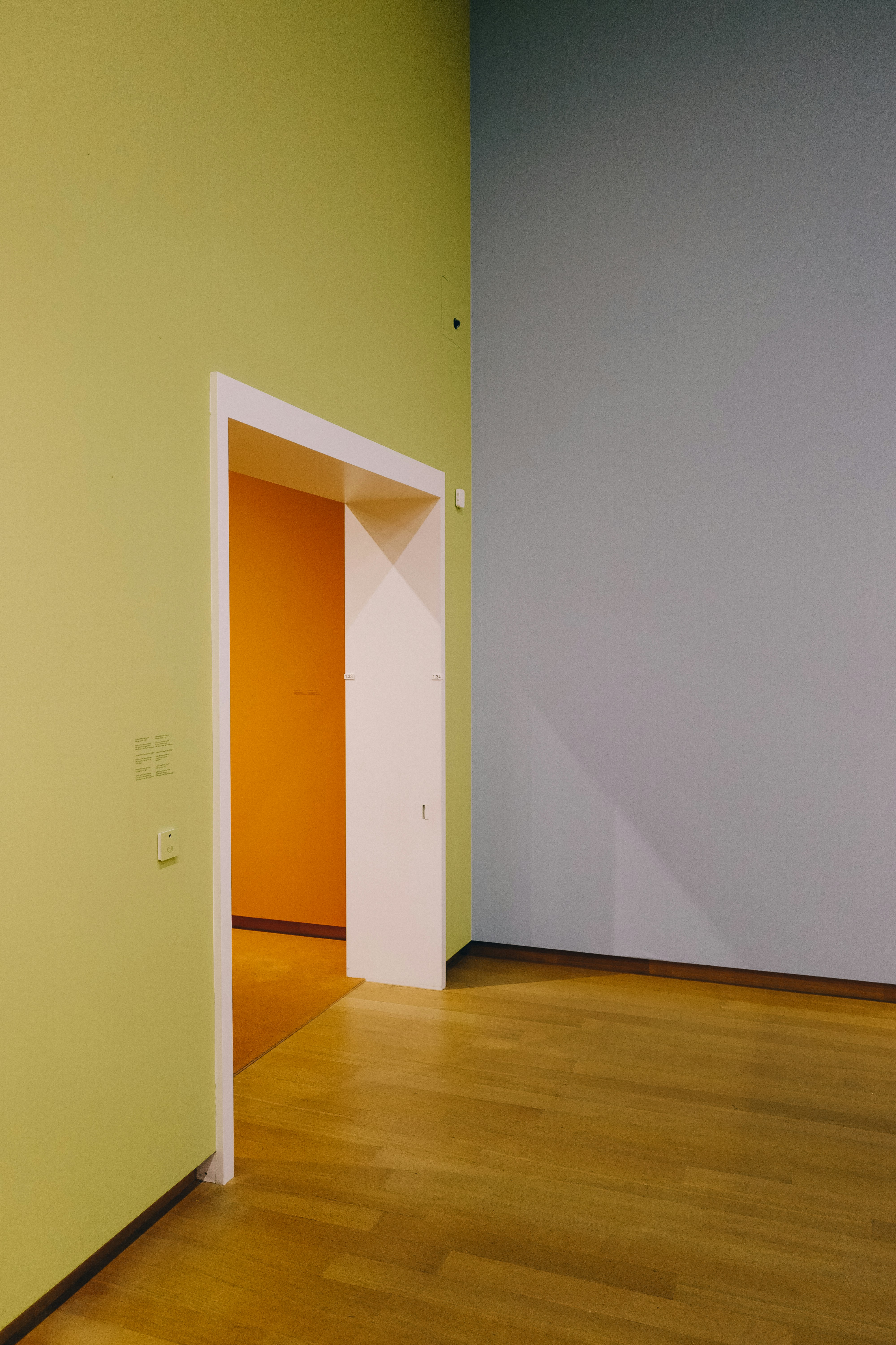 Threshold of Color: Orange Room Through a Pale Green Gallery