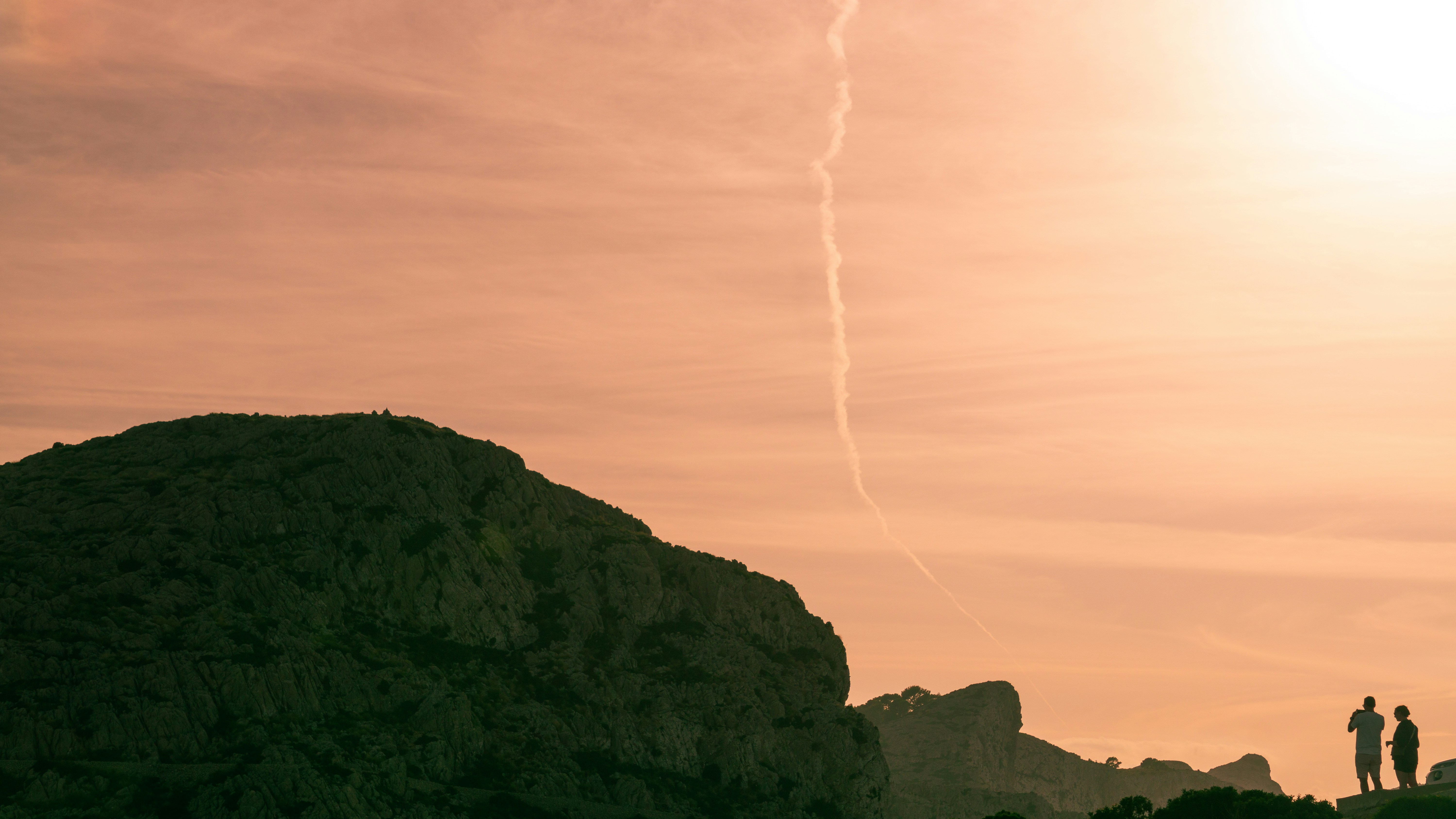 Ember Ridge at Dusk: Silhouettes, Summit, and a Skyward Contrail