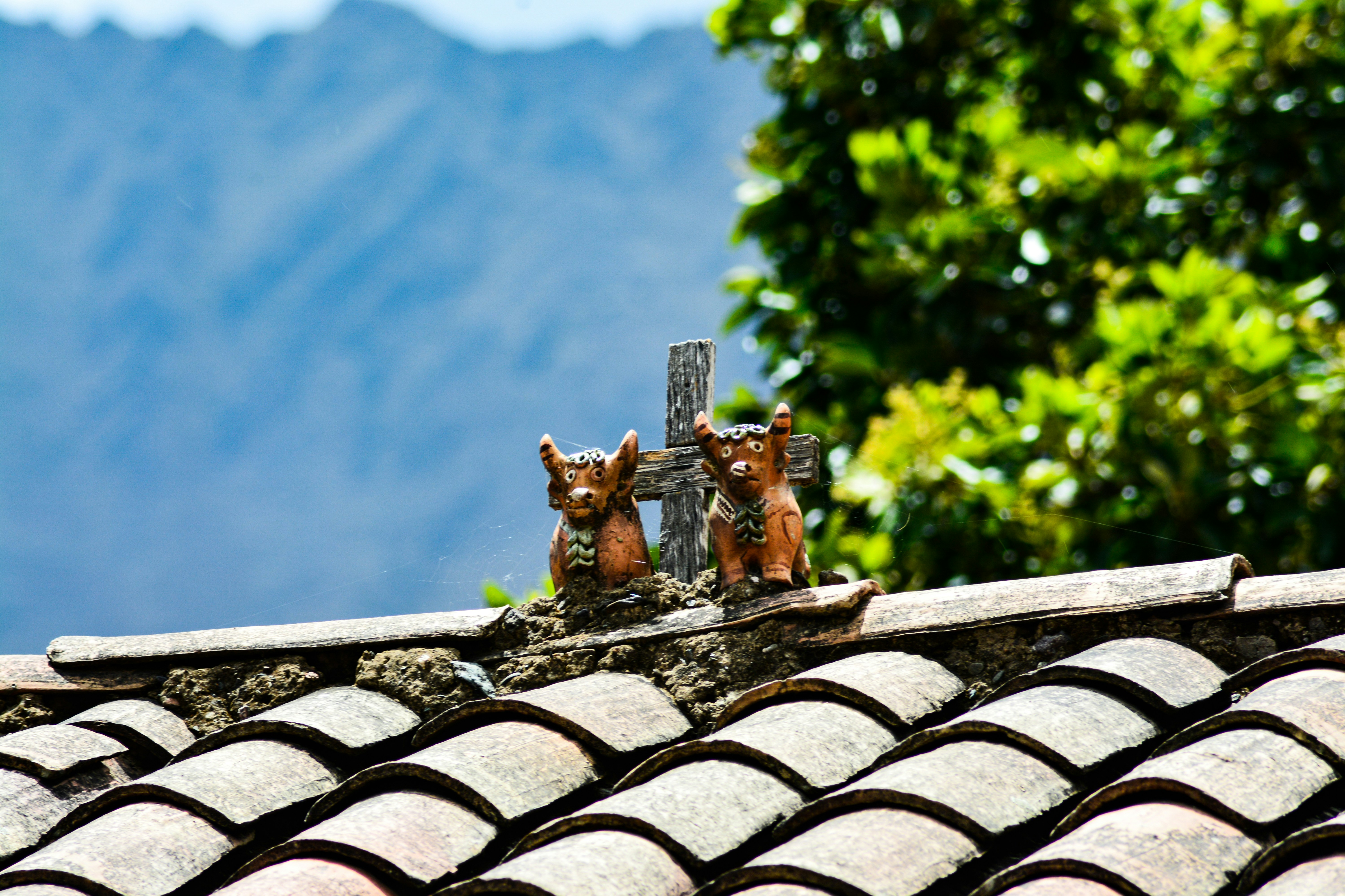 Twin Guardian Figures on the Tile Ridge