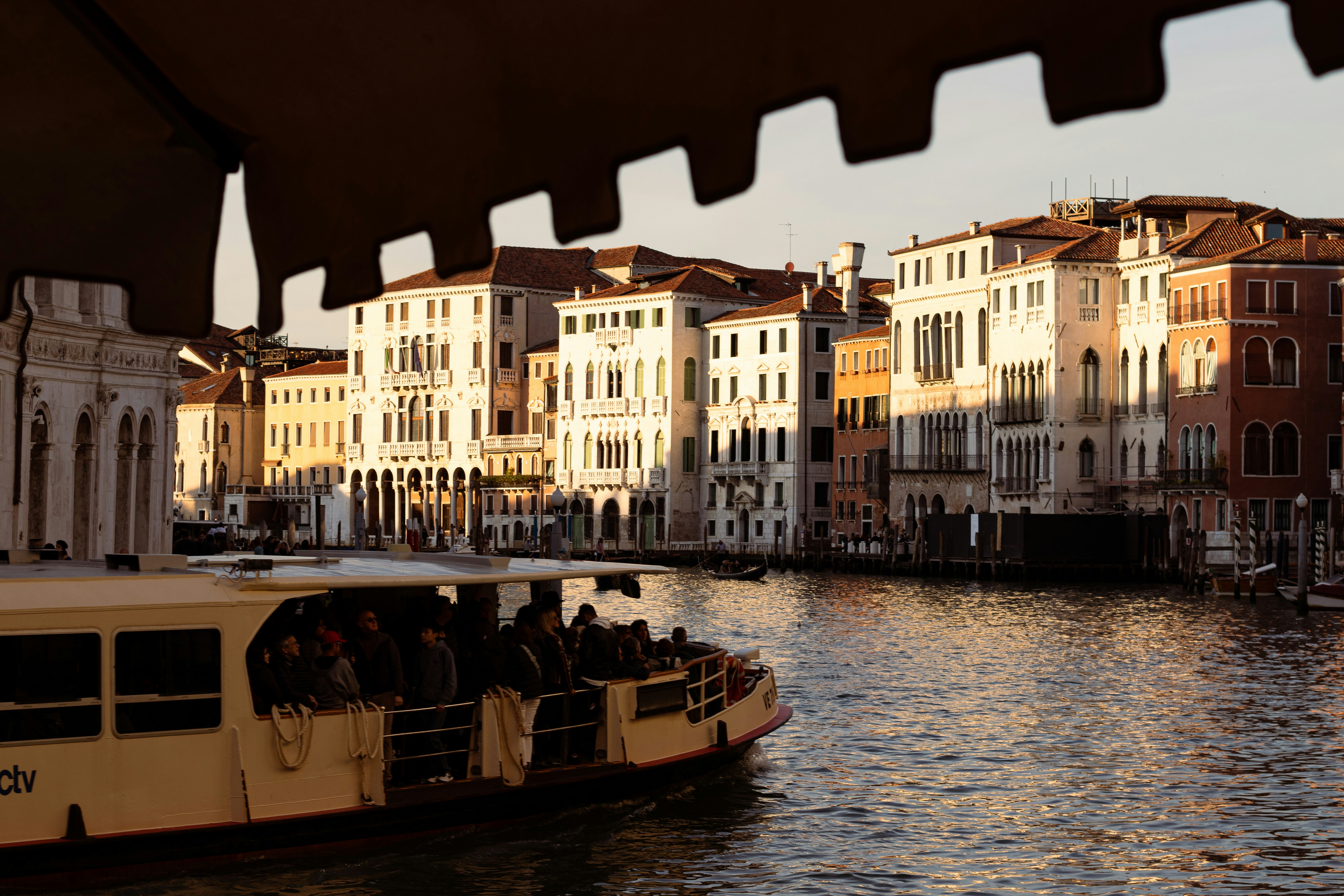 Venetian Evening: Tour Boat Framed by Colorful Facades
