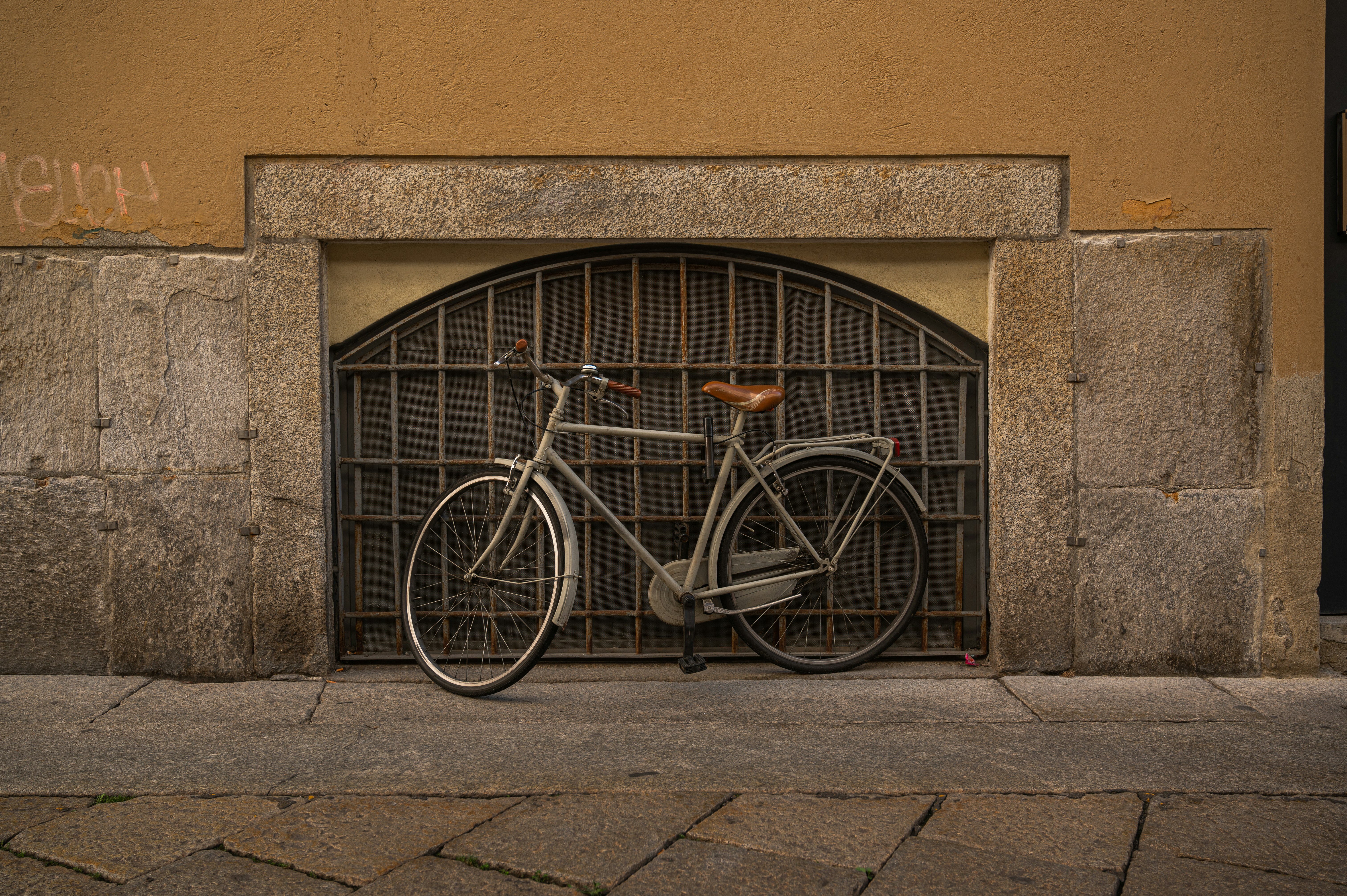 A bicycle parked in front of a gate photo – Free Bicycle Image on Unsplash