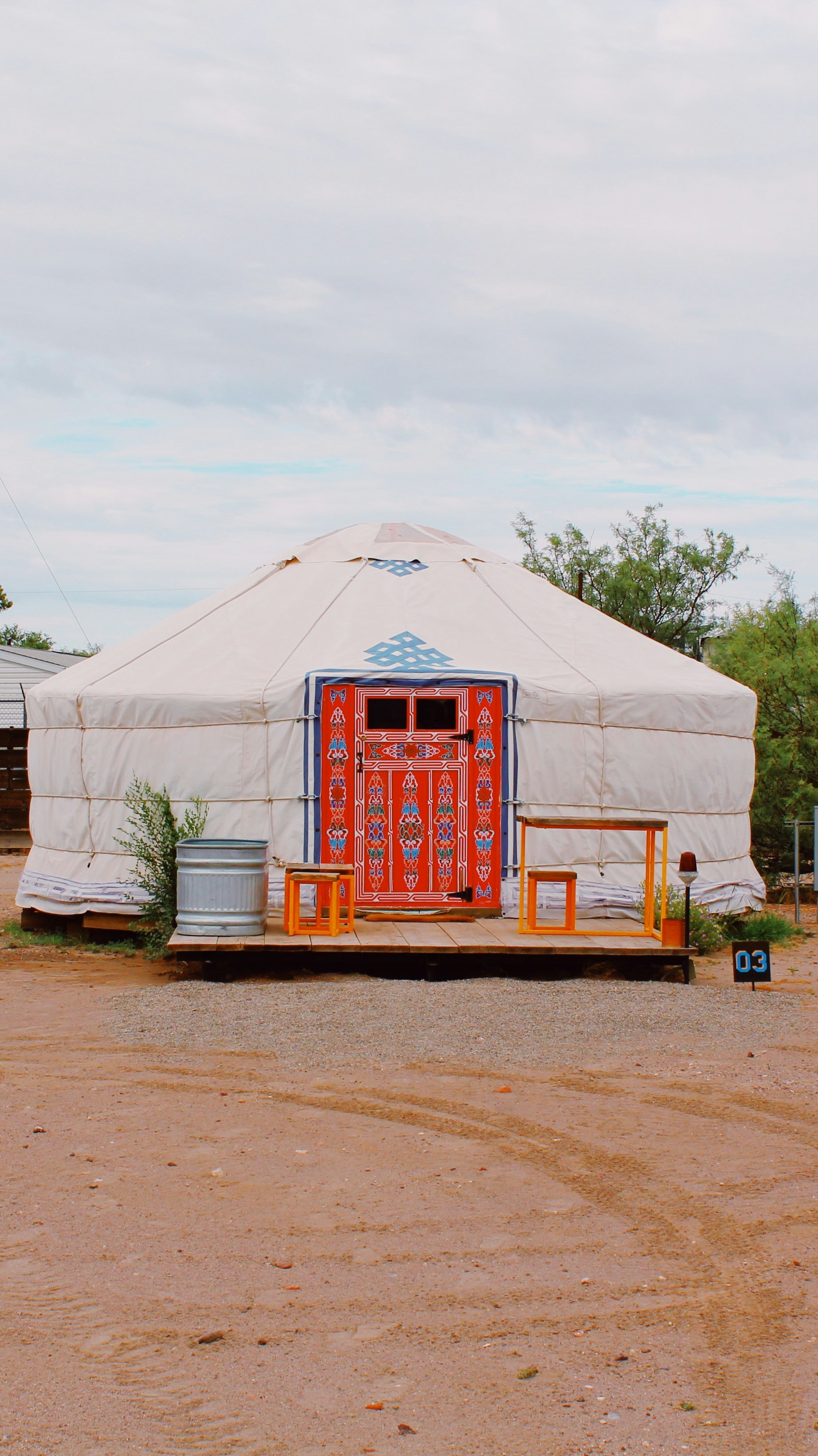 a white tent with a red door