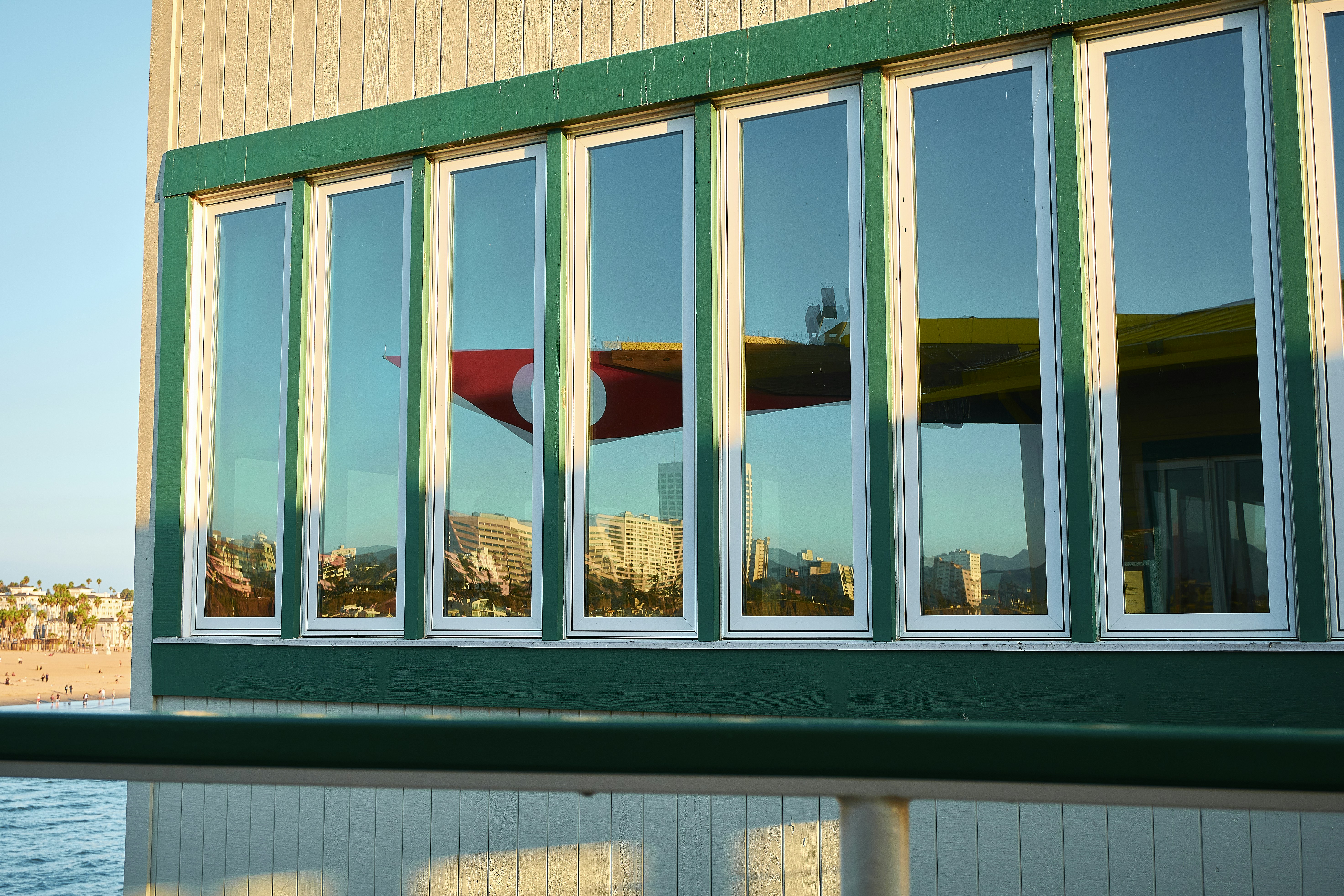 Sunlit windowed storefront and harbor view