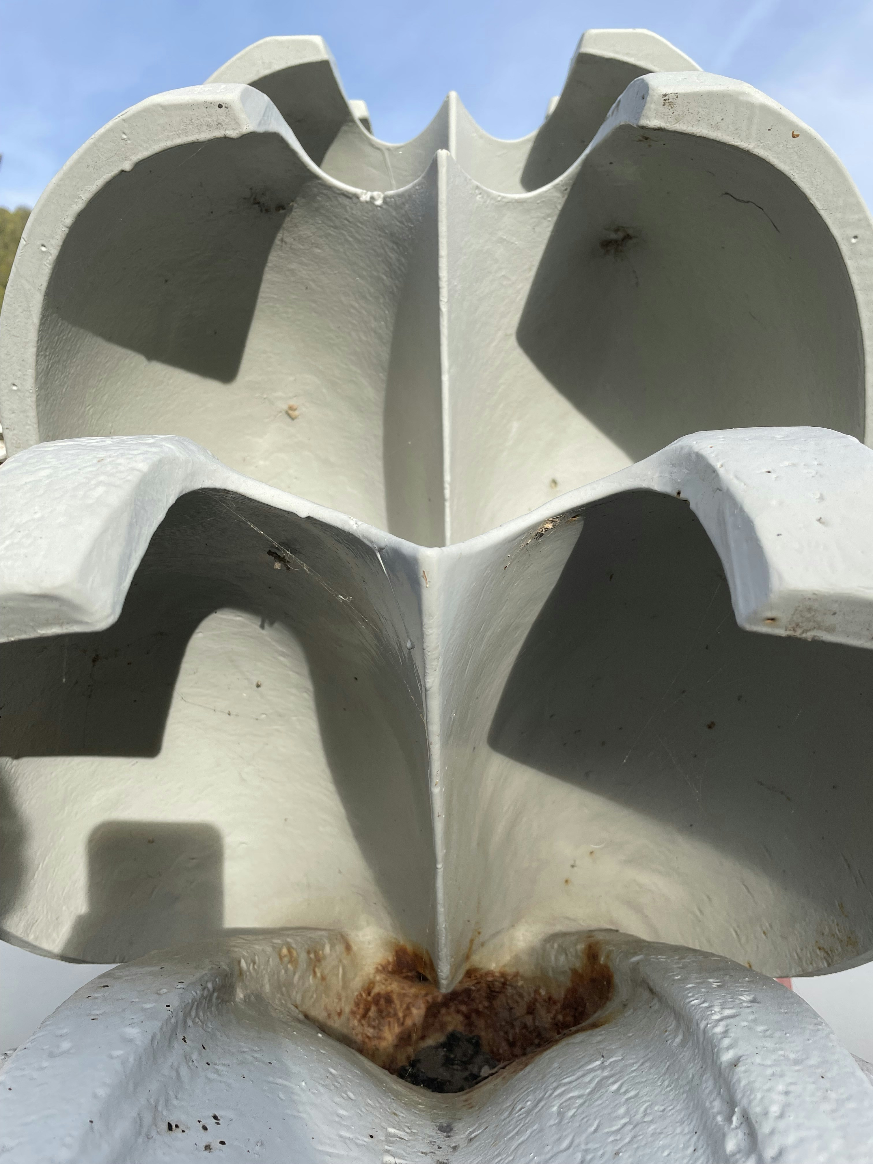 Grey Pleats: close-up of symmetrical, clamshell-like tiles against a blue sky