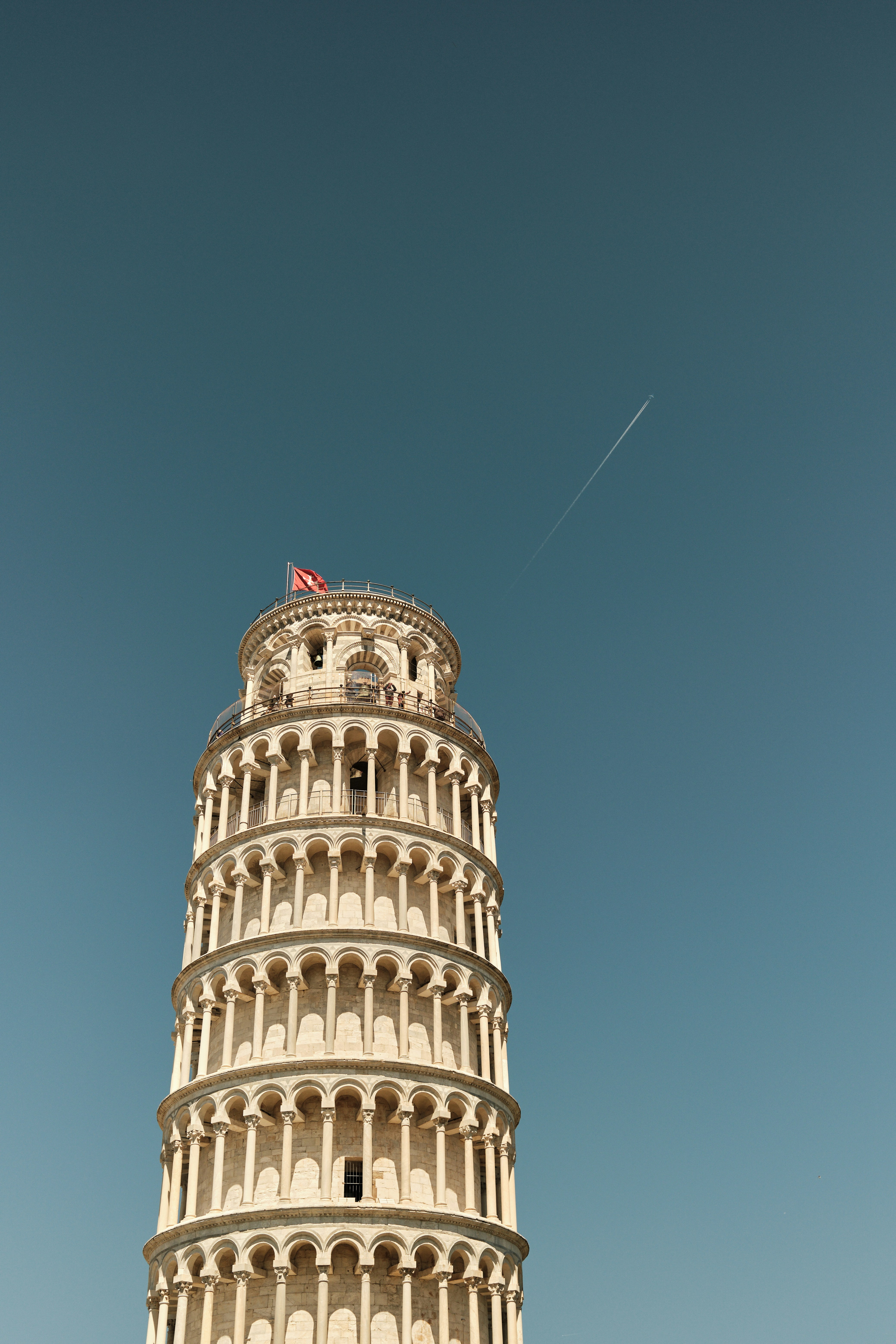 The Leaning Marvel Against a Clear Canvas