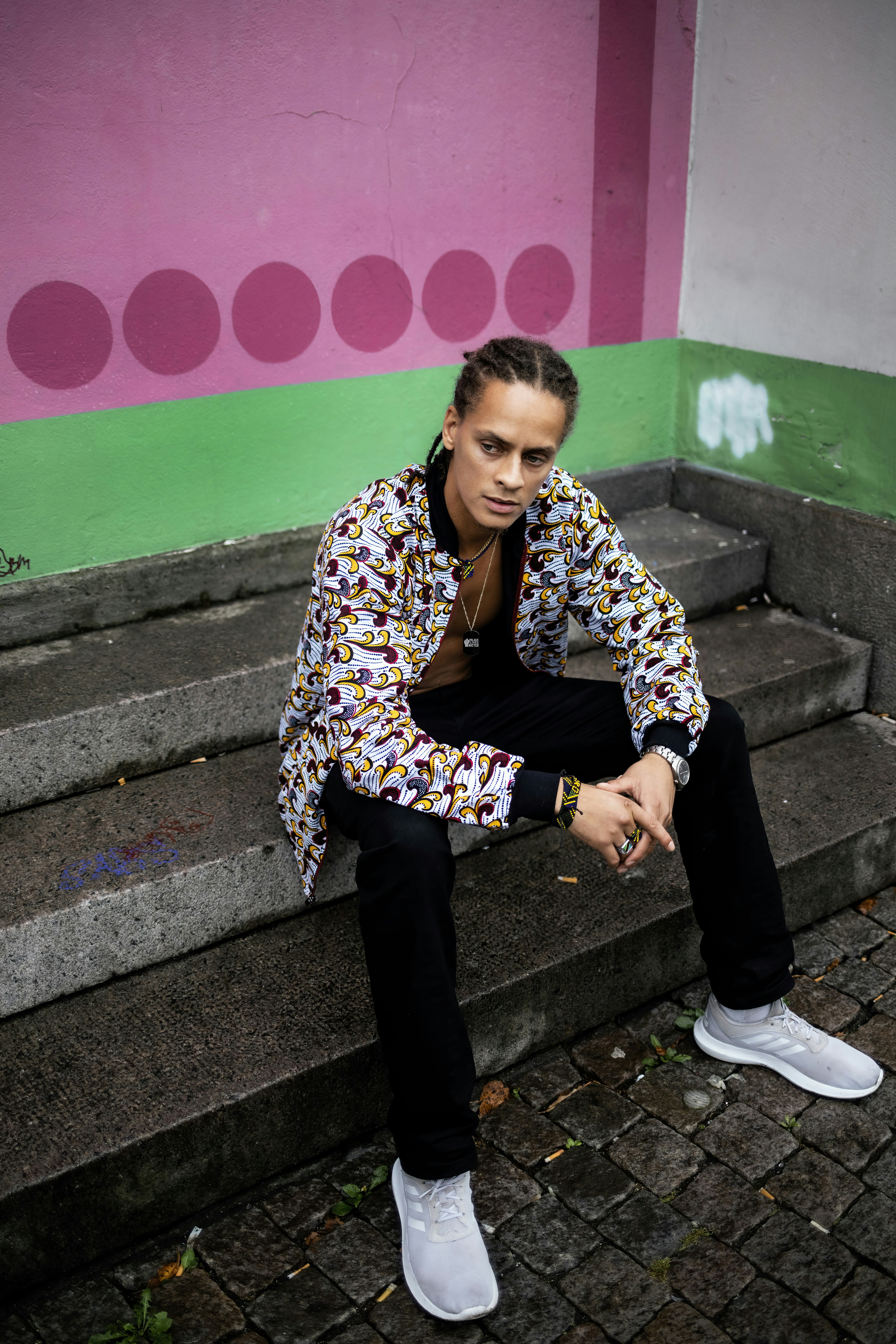 Graffiti Portrait on Verdant Steps: The Confident Moment