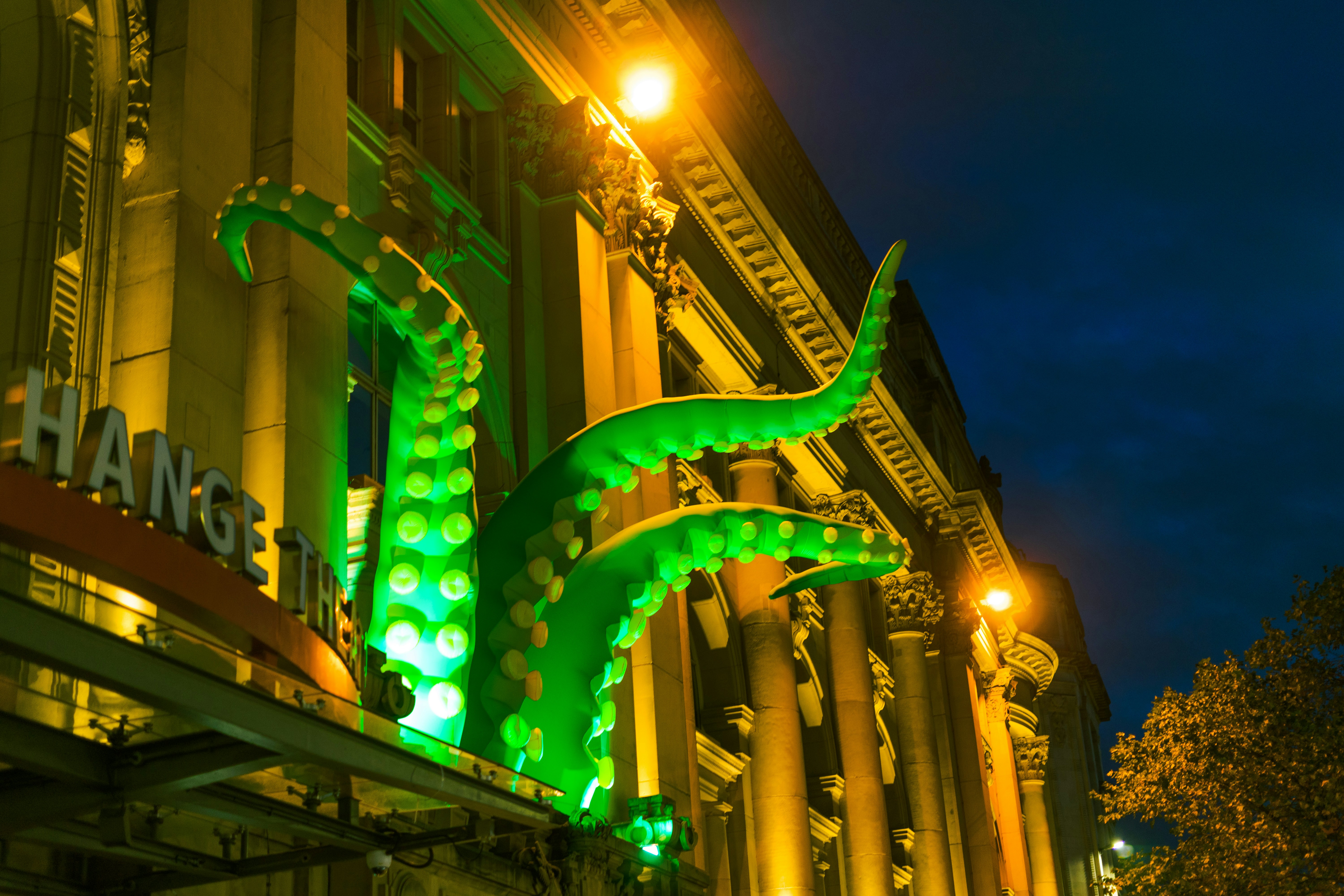 Neon Tentacles Over a Historic Facade