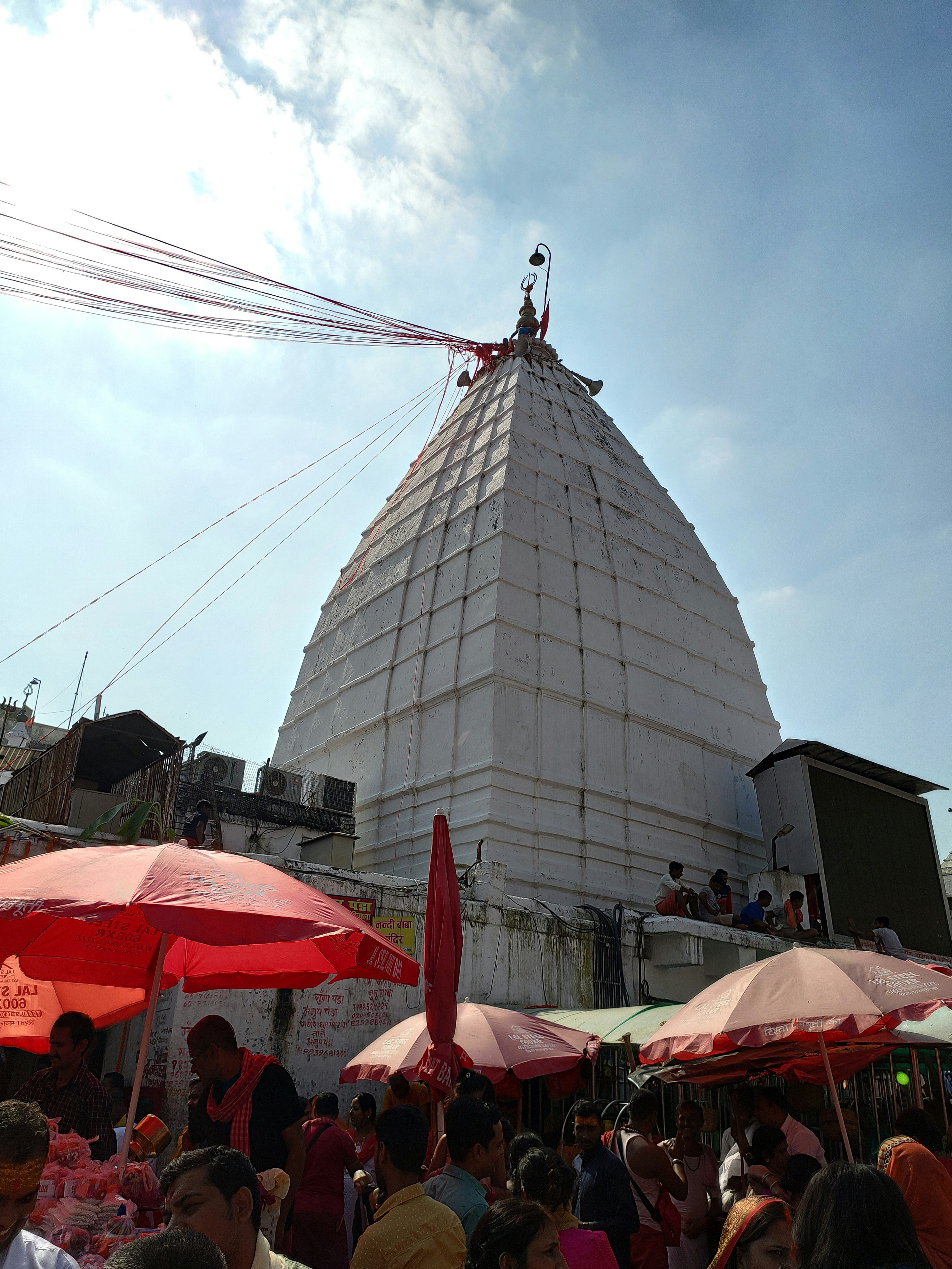 Temple Spire Rising Above a Market of Umbrellas