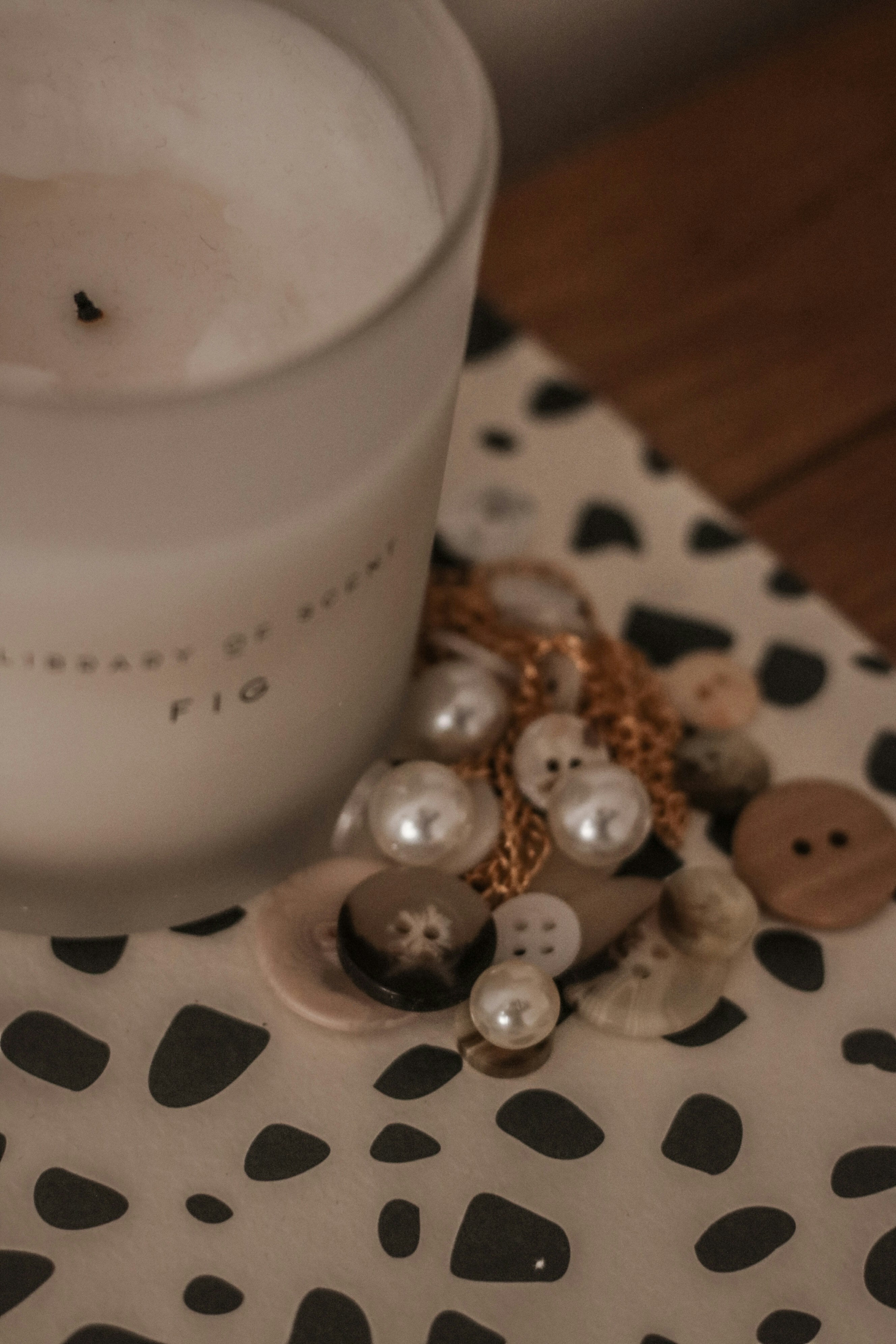 Soft Candlelight and Pearl Accents on Patterned Fabric