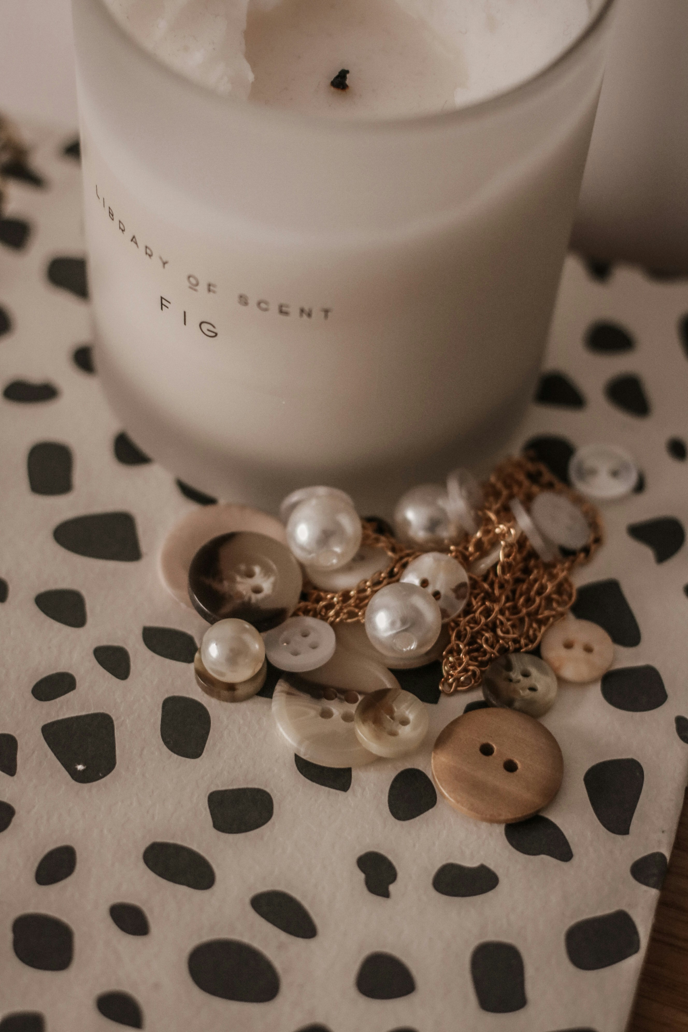 Muted Glow: Candlelight and Pearl Charms in Close-Up