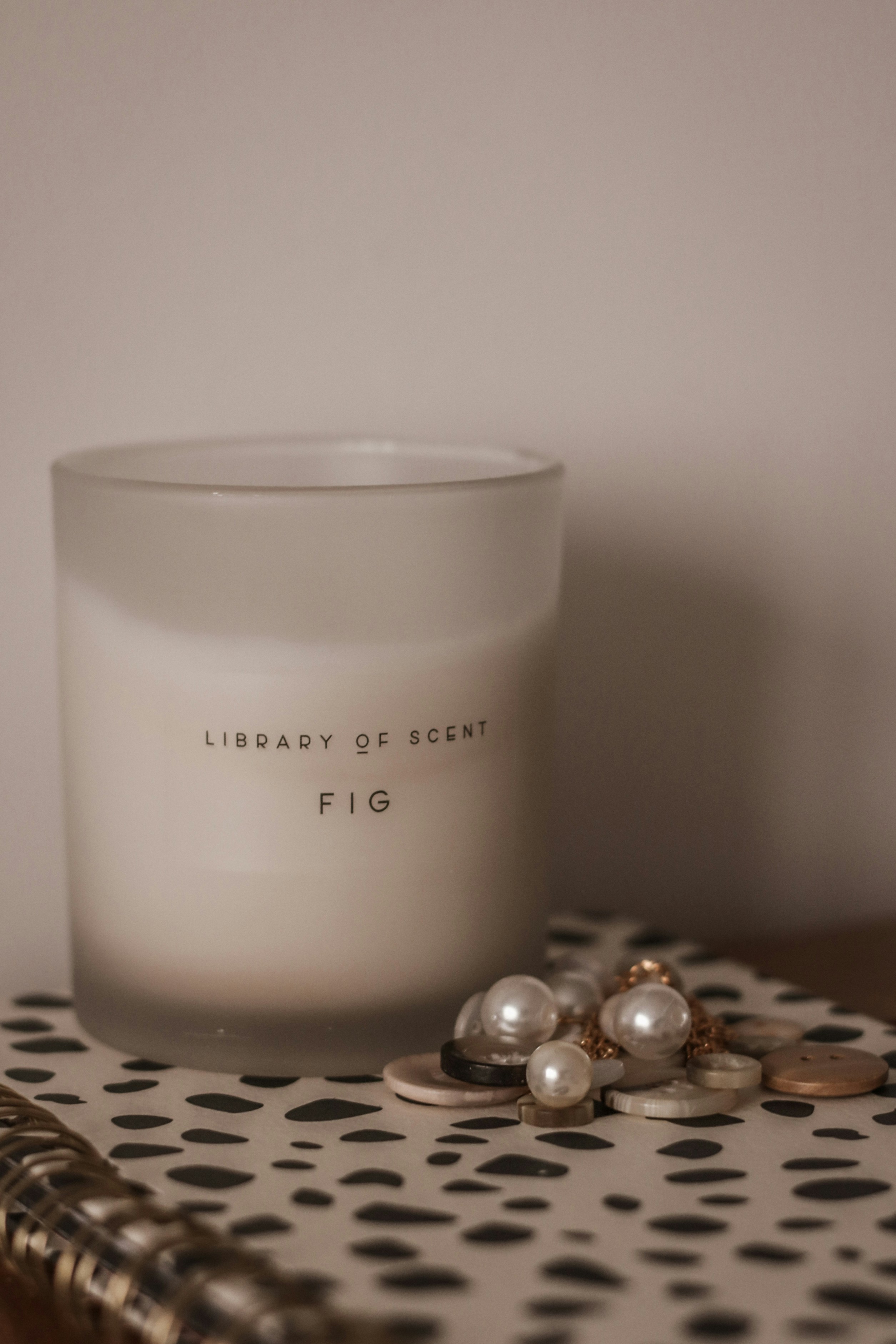 Minimal Luxe: Scented Candle and Pebble Stack on a Dotted Tray