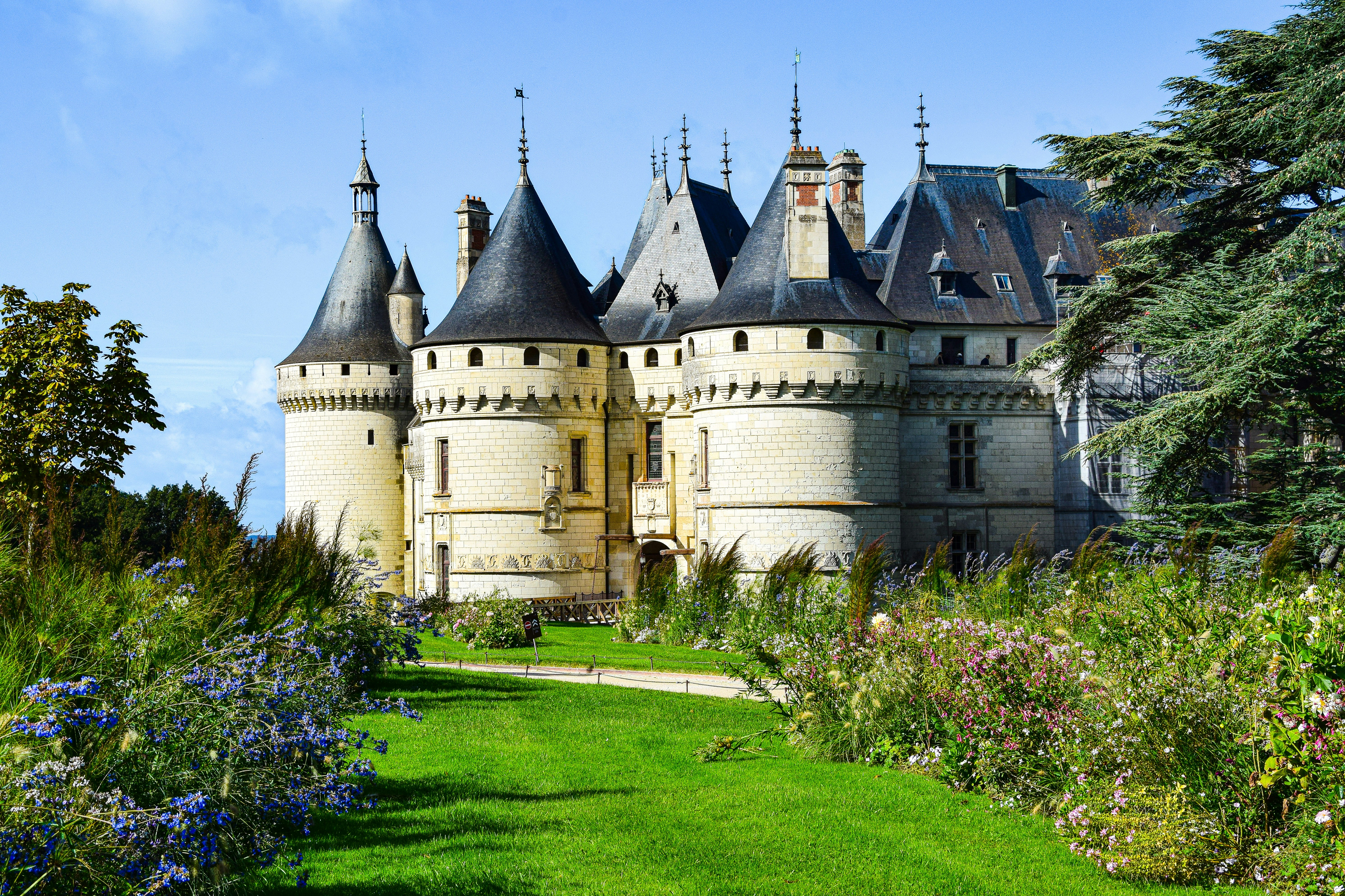A castle with many pointed rooftops with Château de Chaumont in the ...
