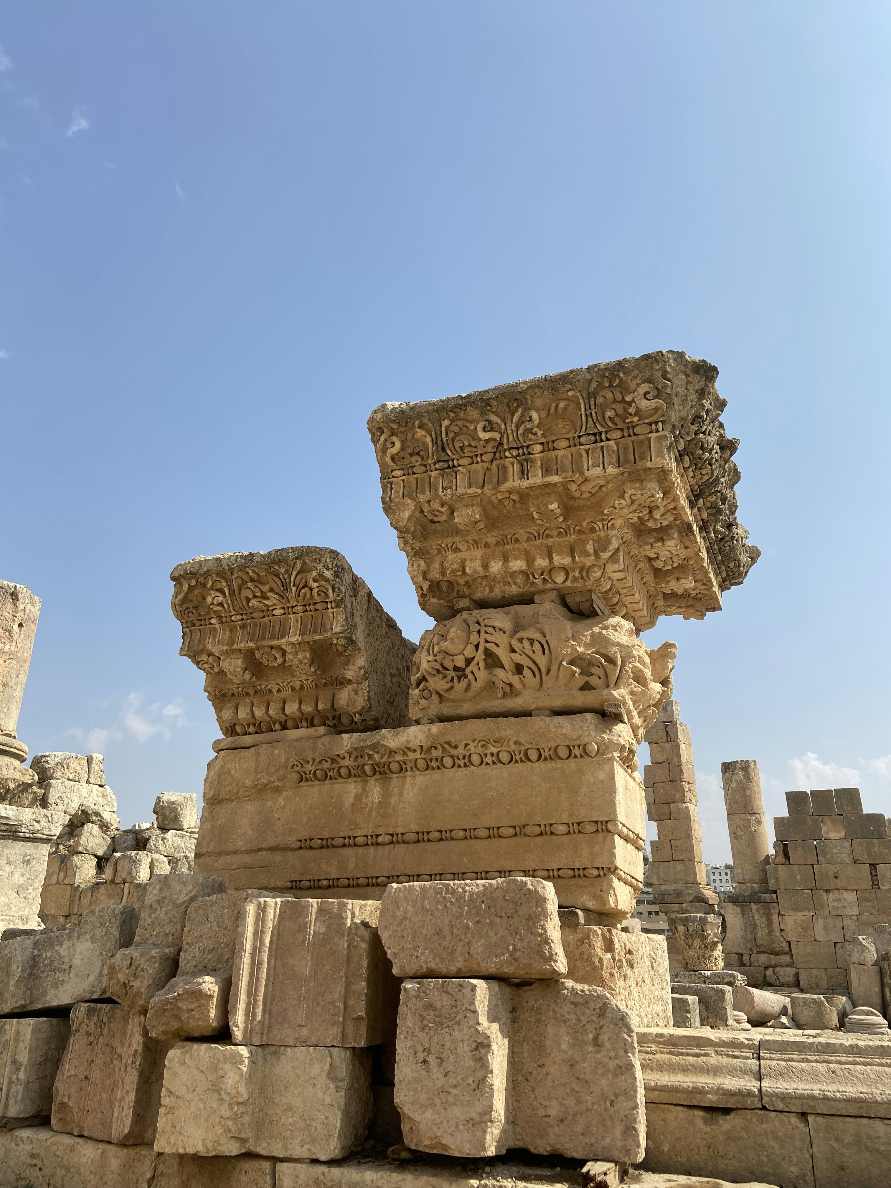Architectural designs spotted in the ancient city of Jerash, Jordan. | a stone structure with a statue on top