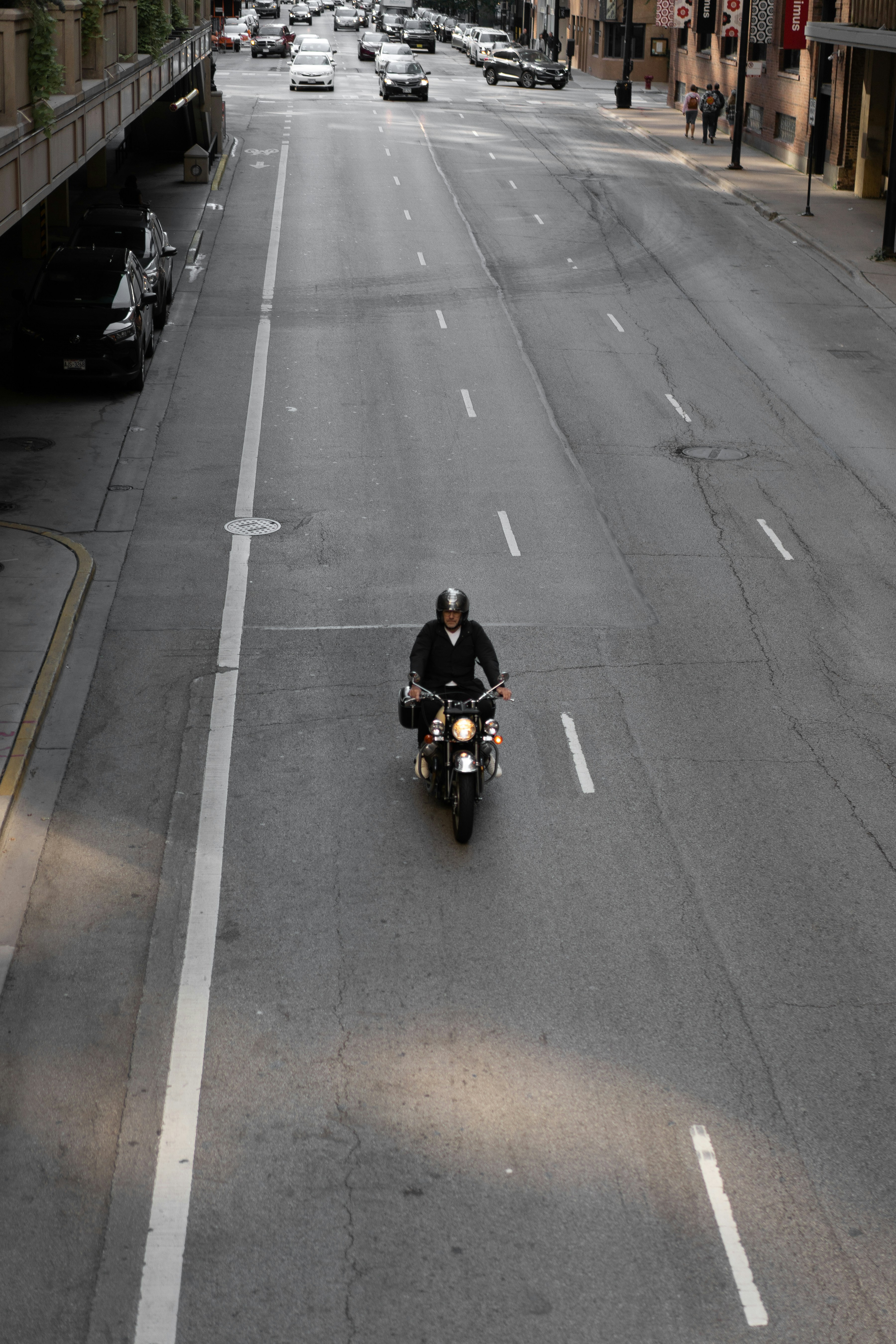 Centerline Pulse: A Solo Rider Traverses a Quiet Downtown Street