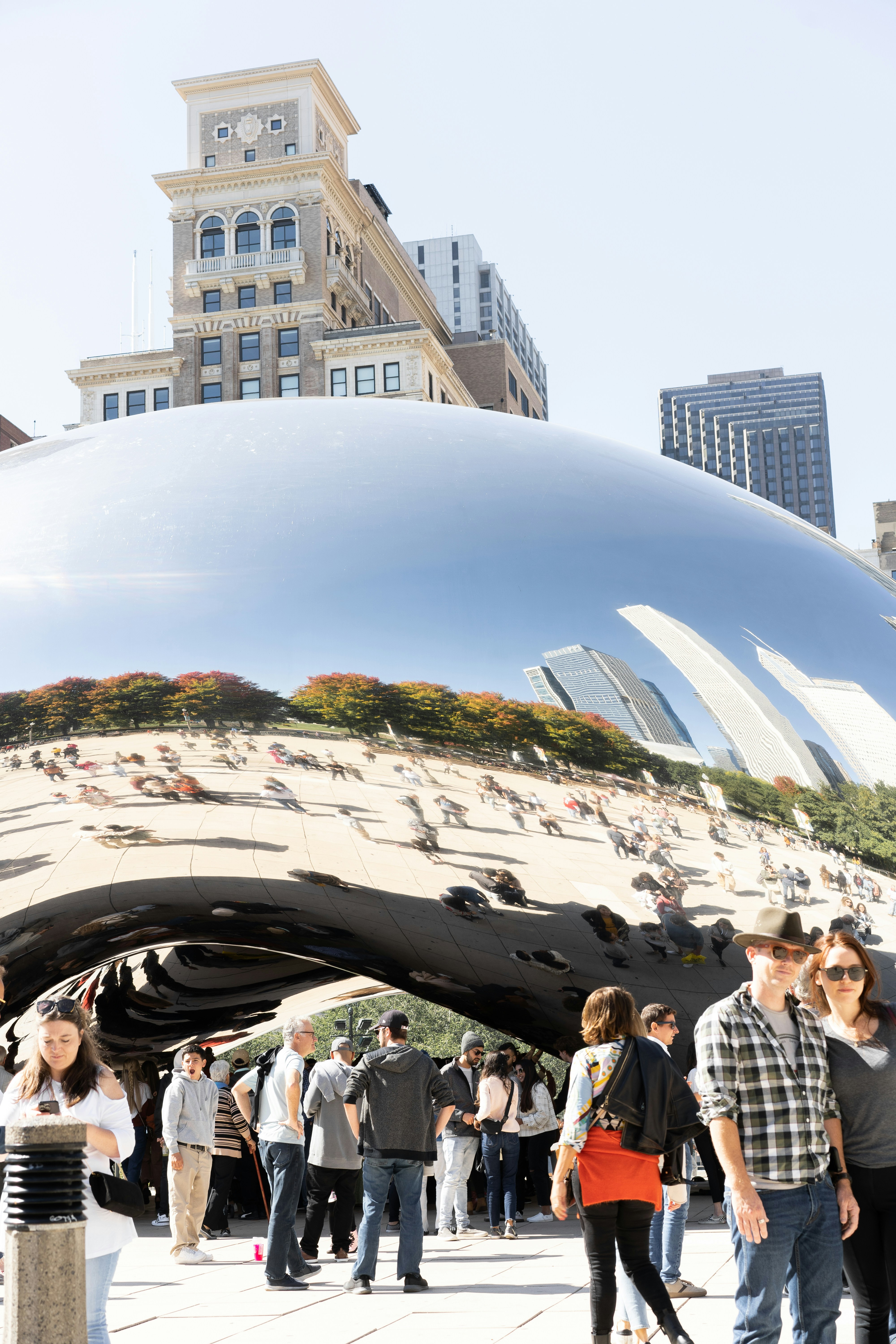 A group of people standing around a reflective sphere photo – Free ...