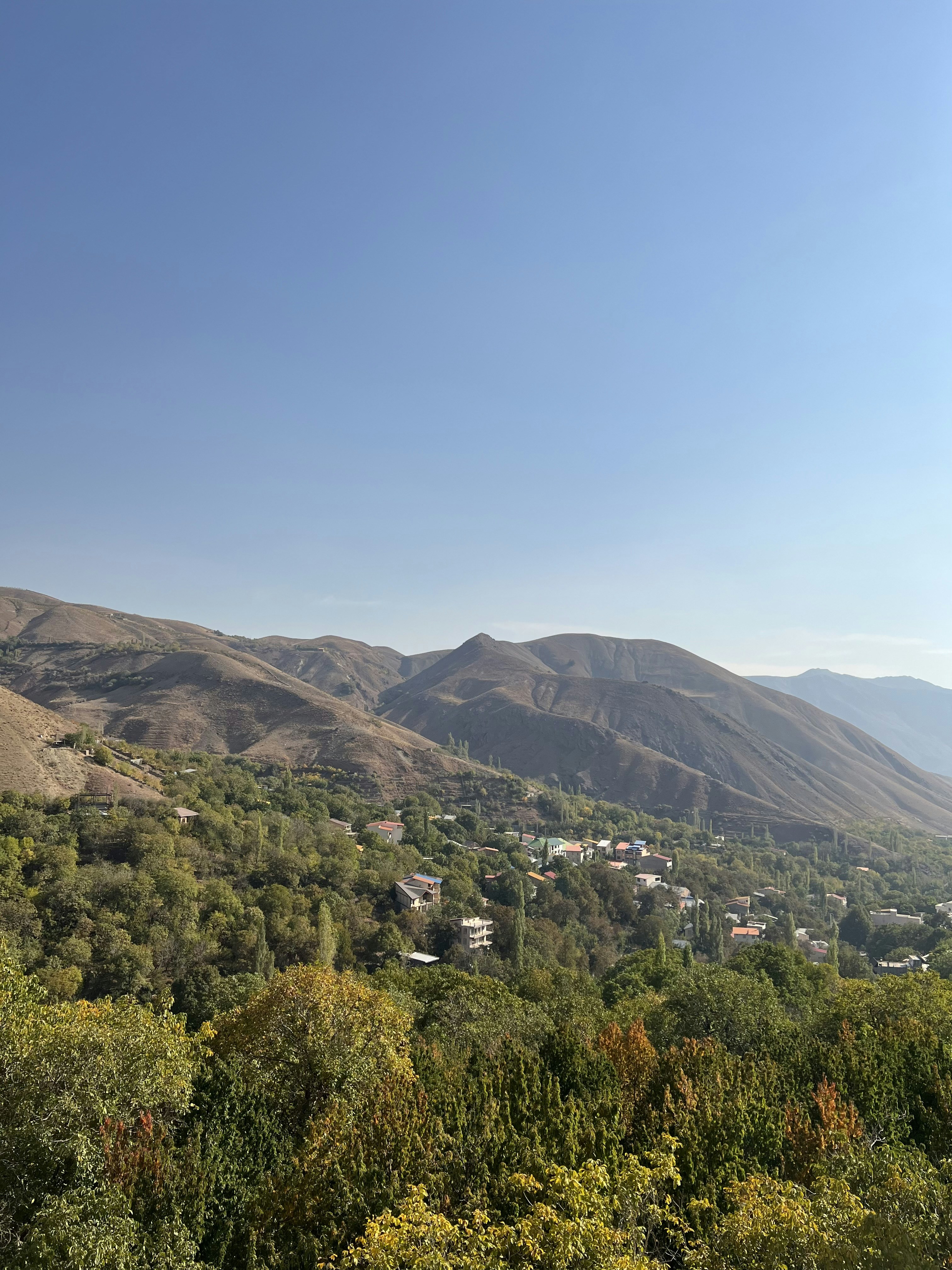 A small town in the valley between mountains photo – Free Woodland ...