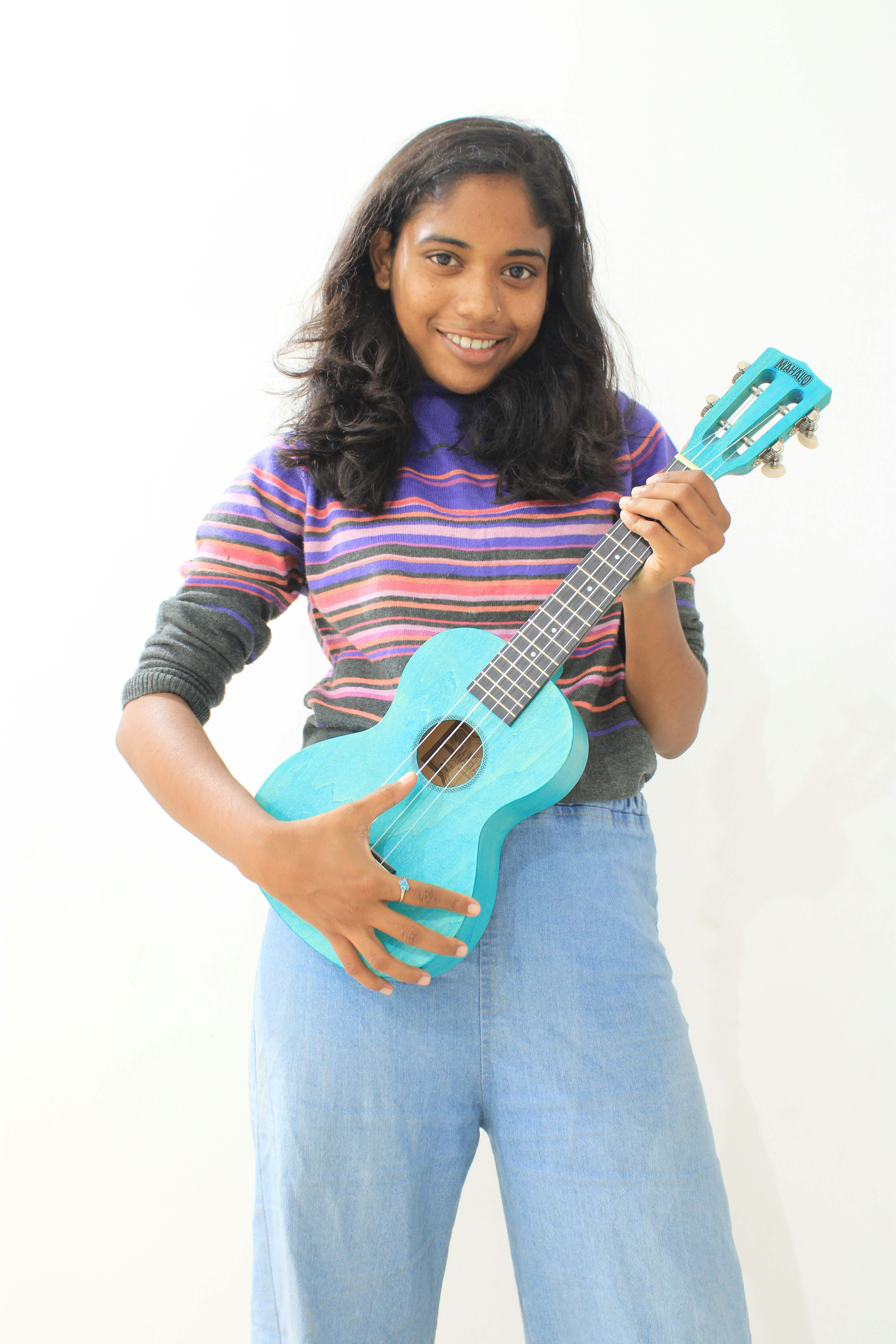 Turquoise Ukulele Portrait: A Bright Smile in a Striped Sweater