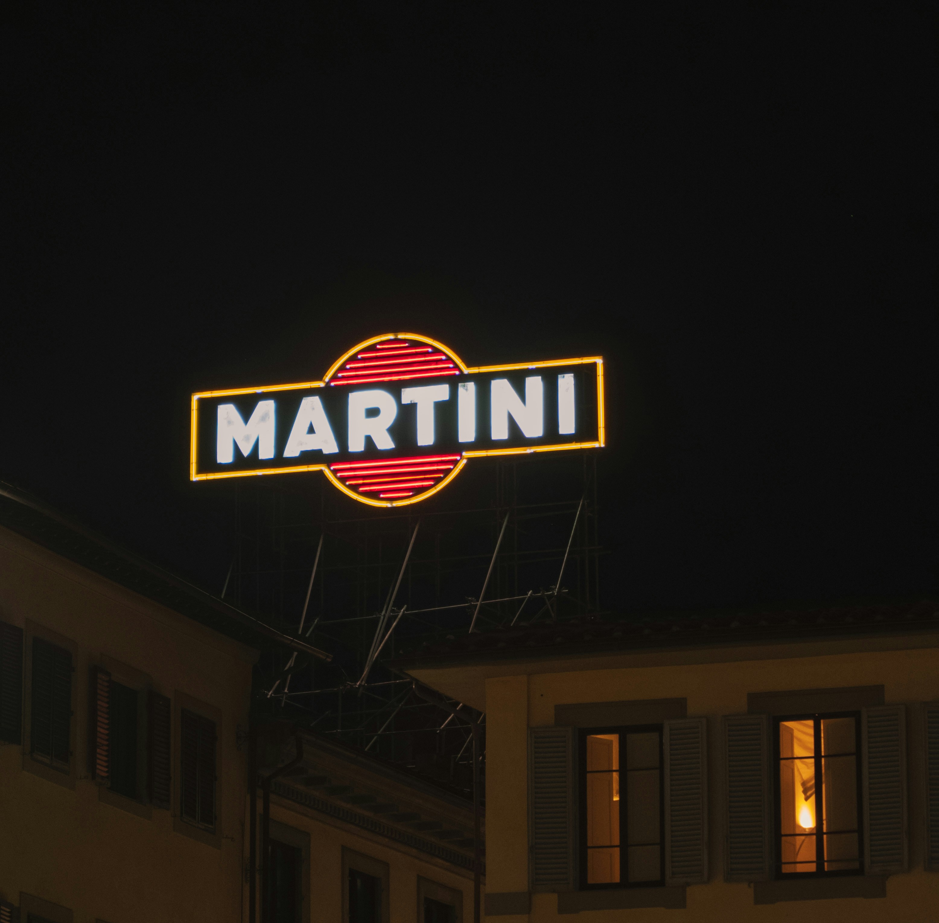Neon Martini Sign: A Warm Beacon Over a Quiet European Night