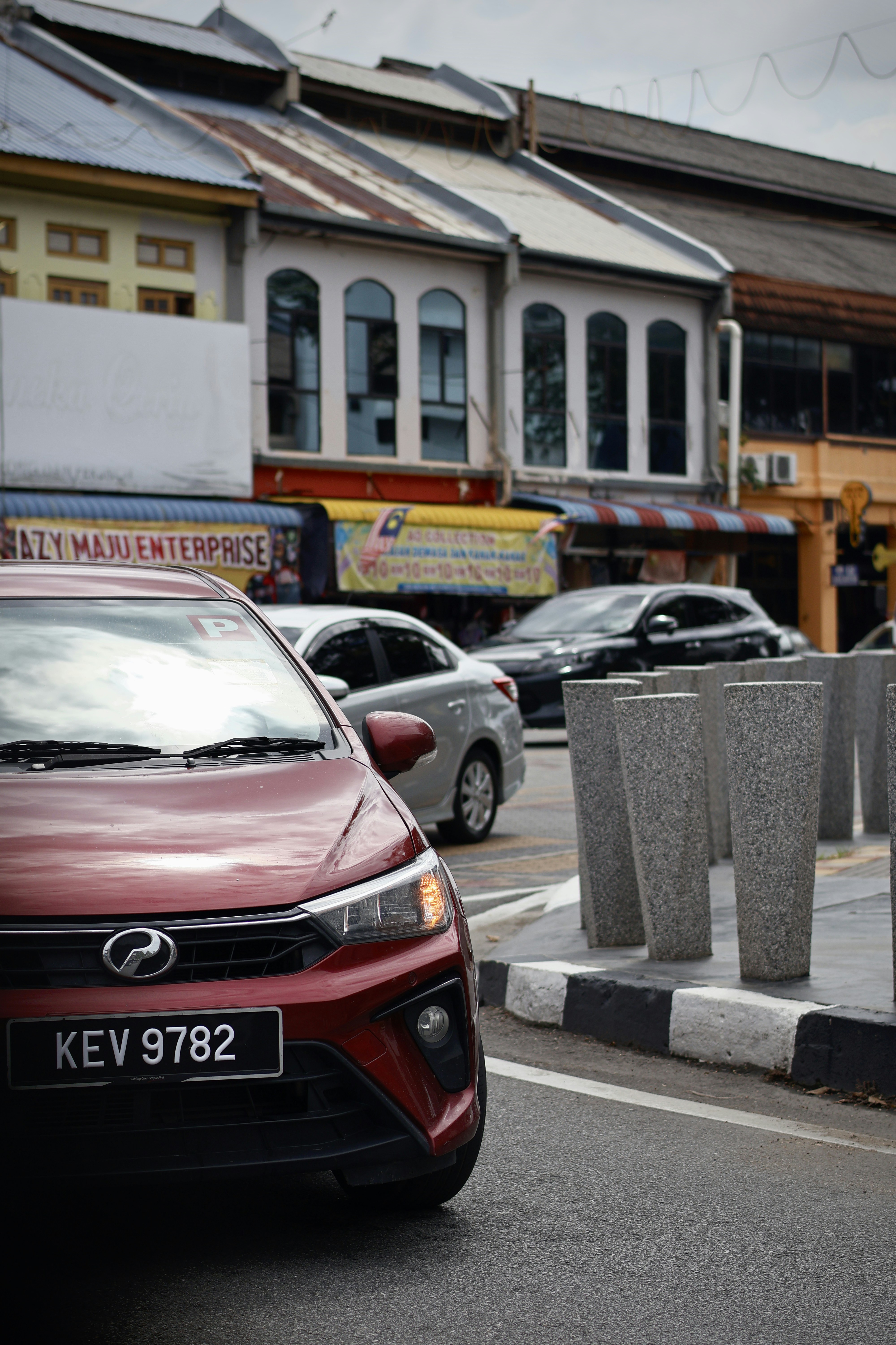 Red Hatchback at the Market Corner: A Street Snapshot