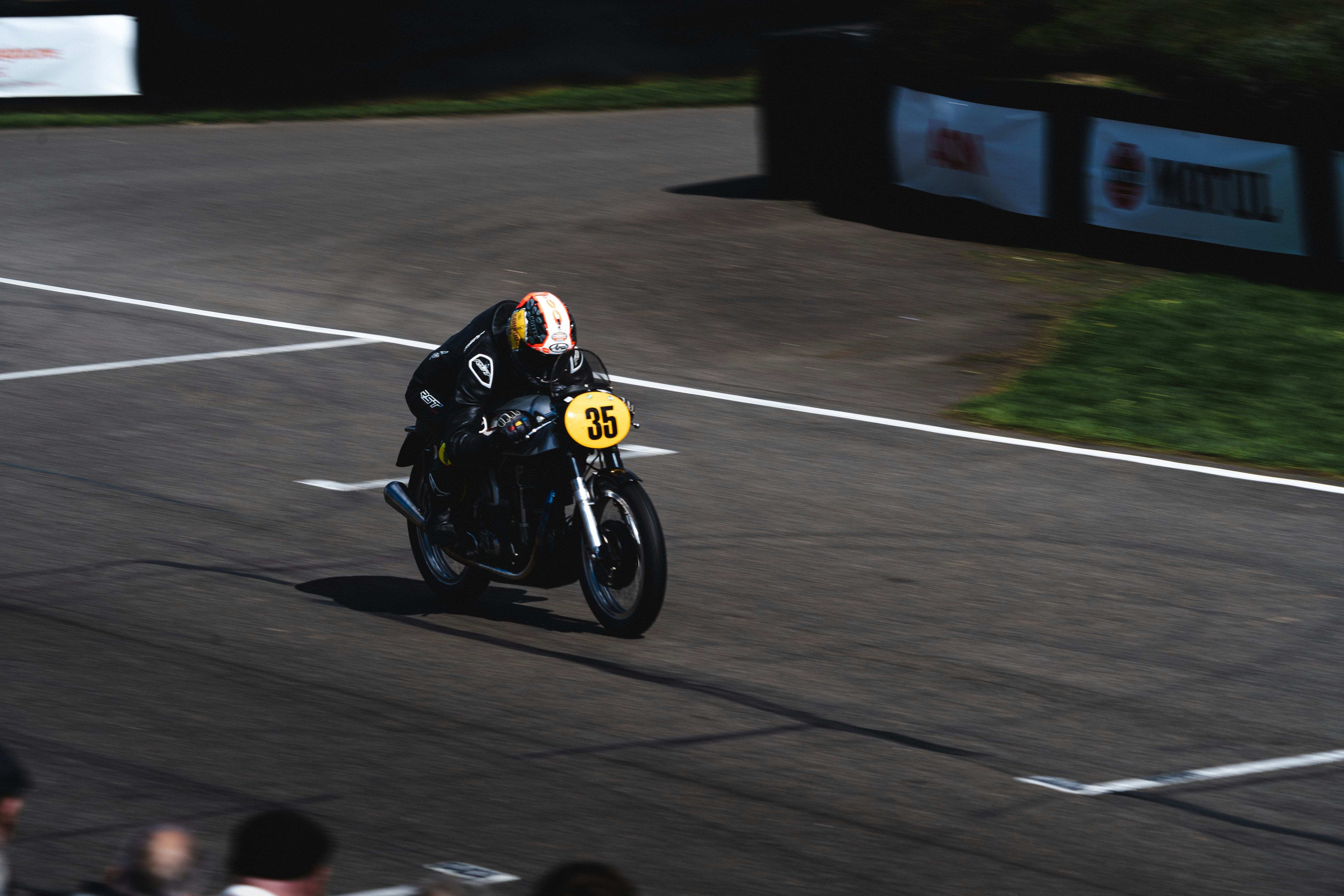 Rider 35 Leaned into the Curve on a Sunlit Racetrack
