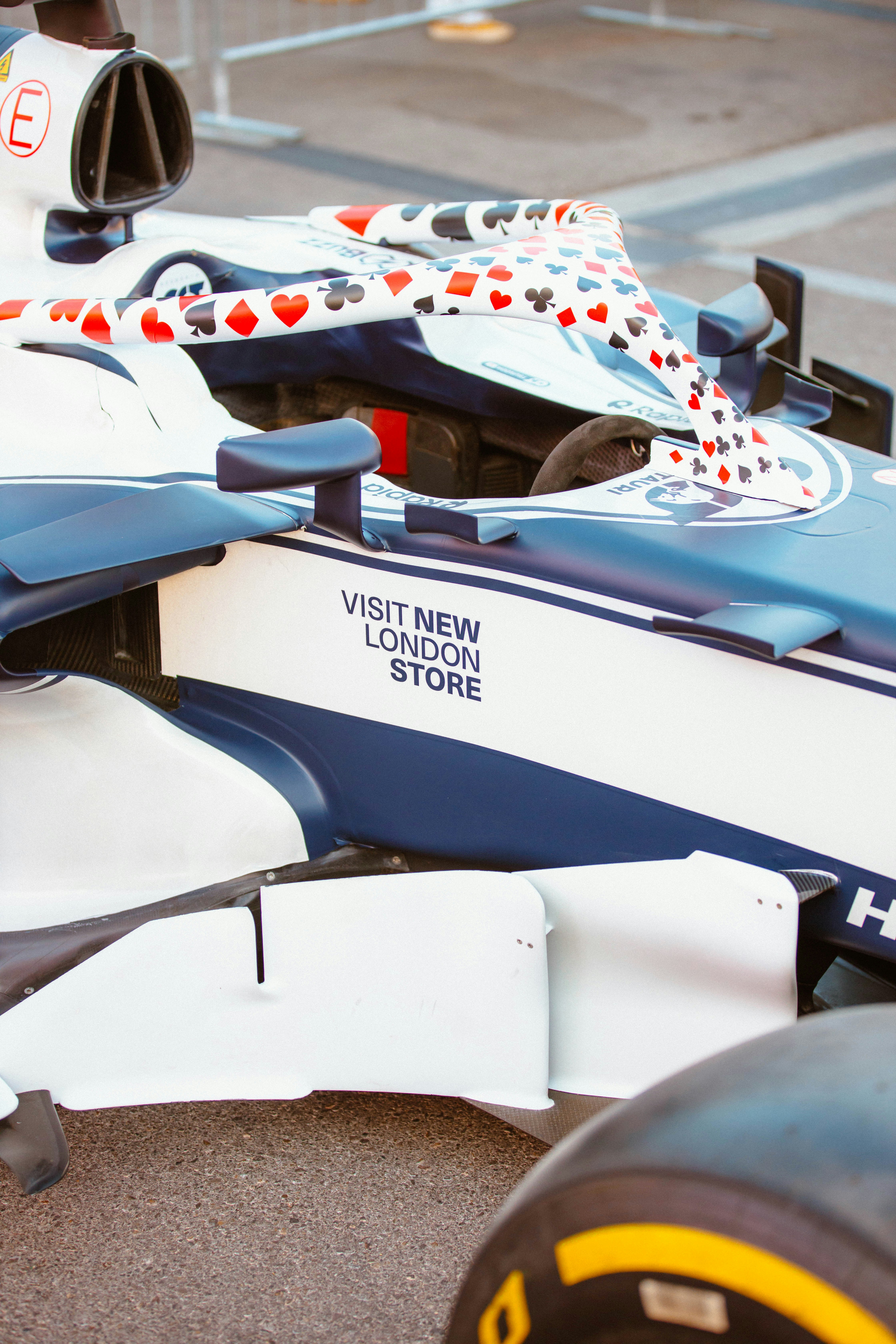 Ace of Asphalt: A Formula Car in the Pit with Card-Patterned Tape