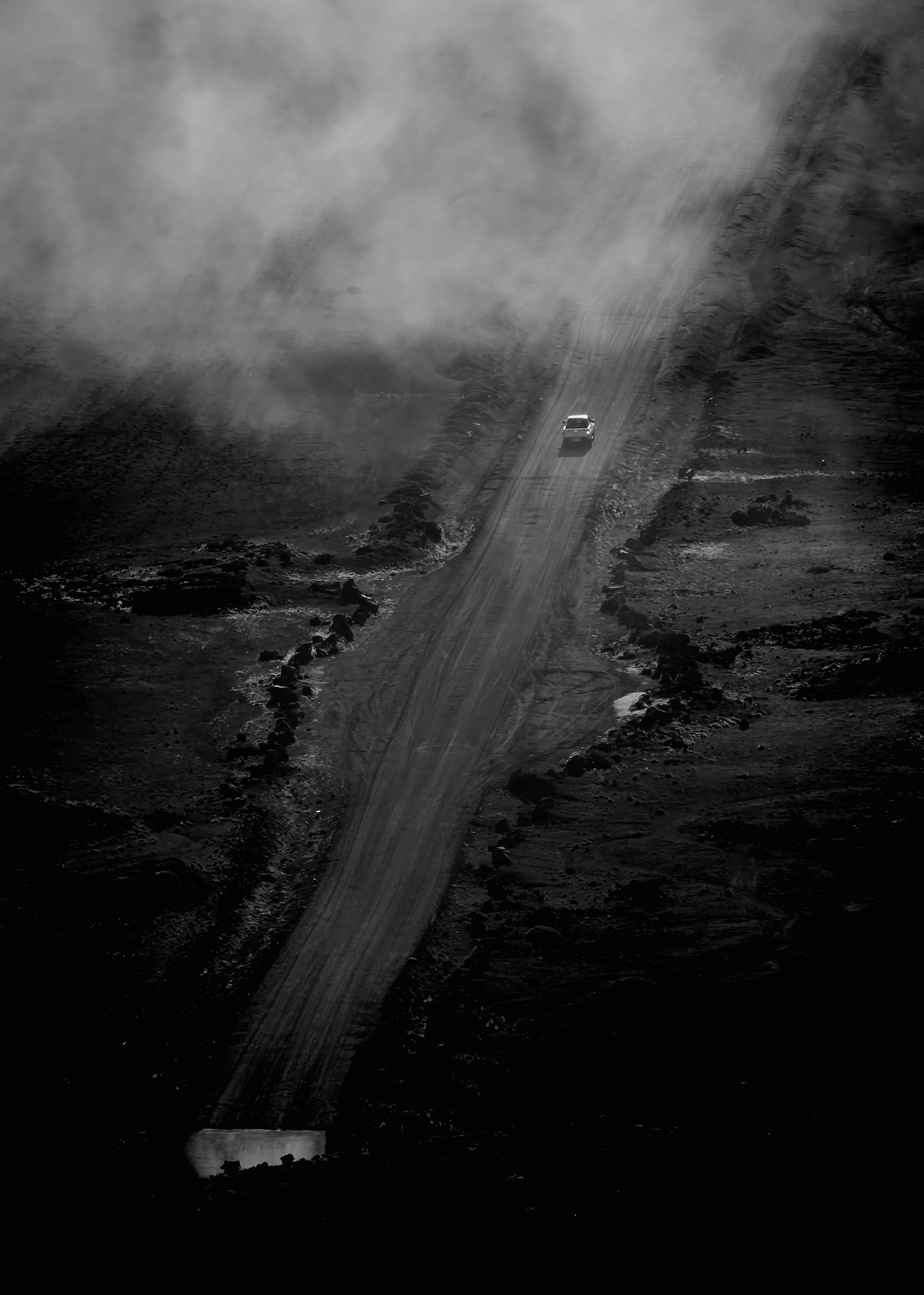 Fogbound Ridge: A Lone Car Climbs a Mist-Soaked Highway