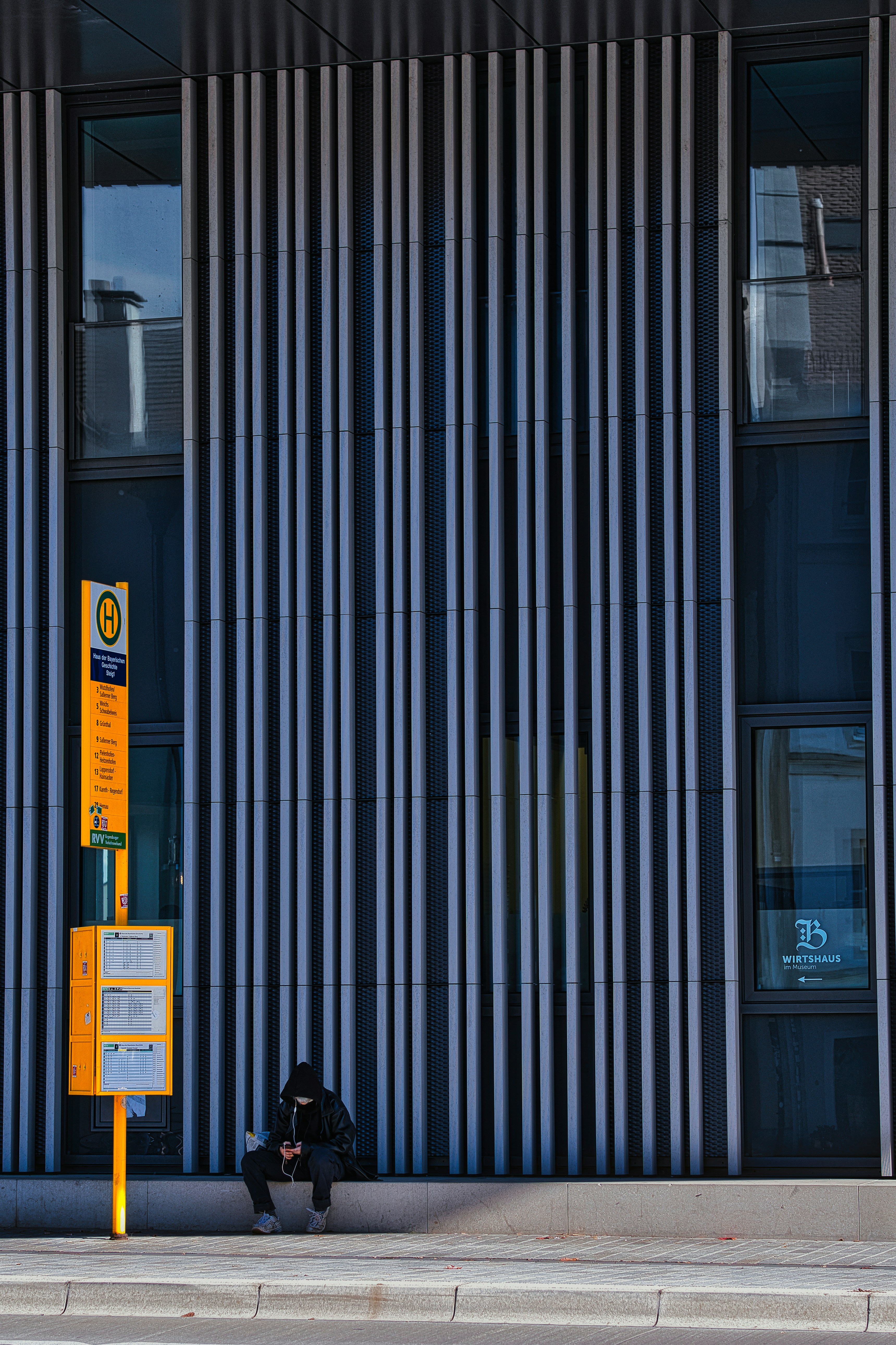 Hooded Moment at the Striped Facade