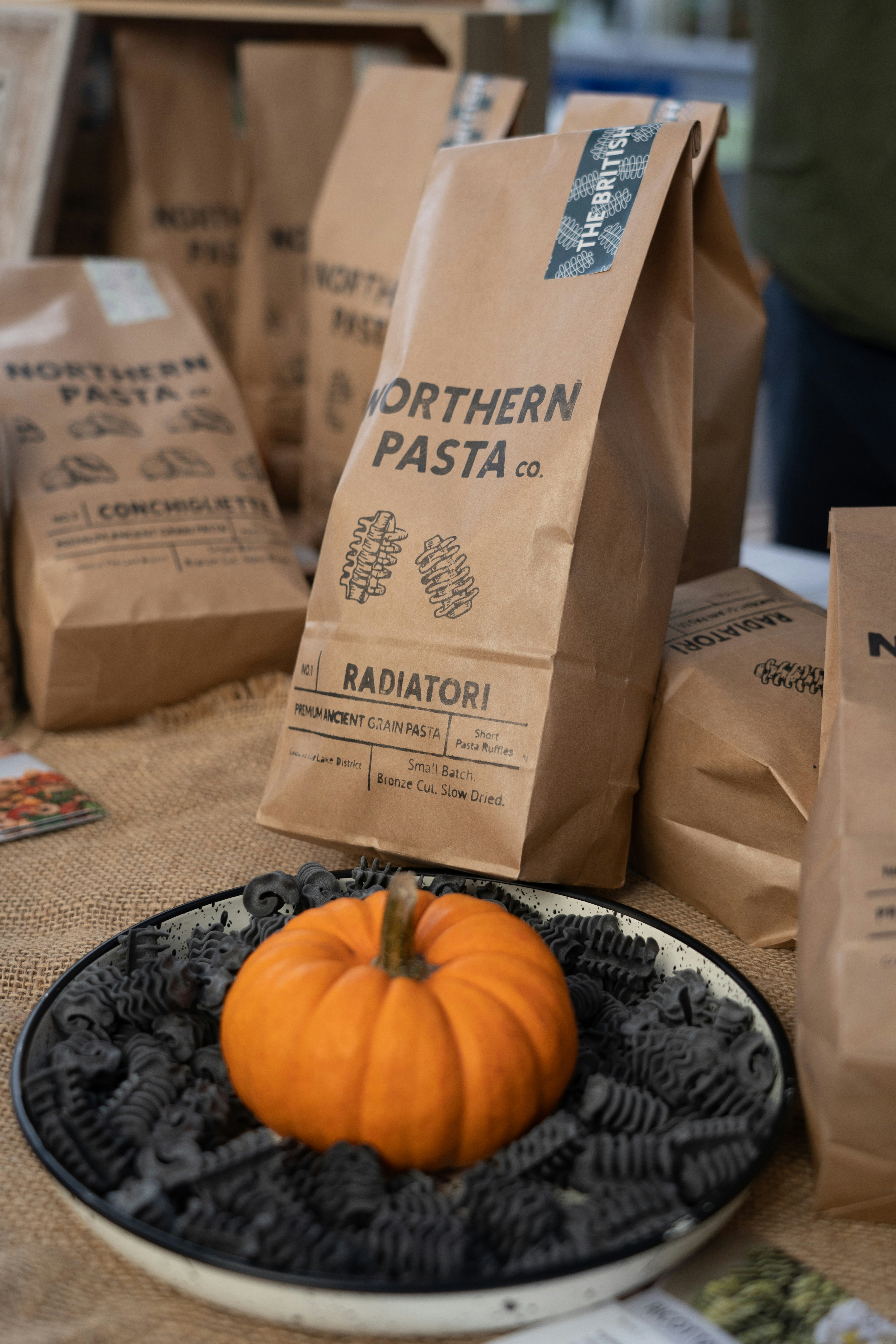 A pumpkin in a bowl with cardboard boxes behind it photo – Free Kendal ...