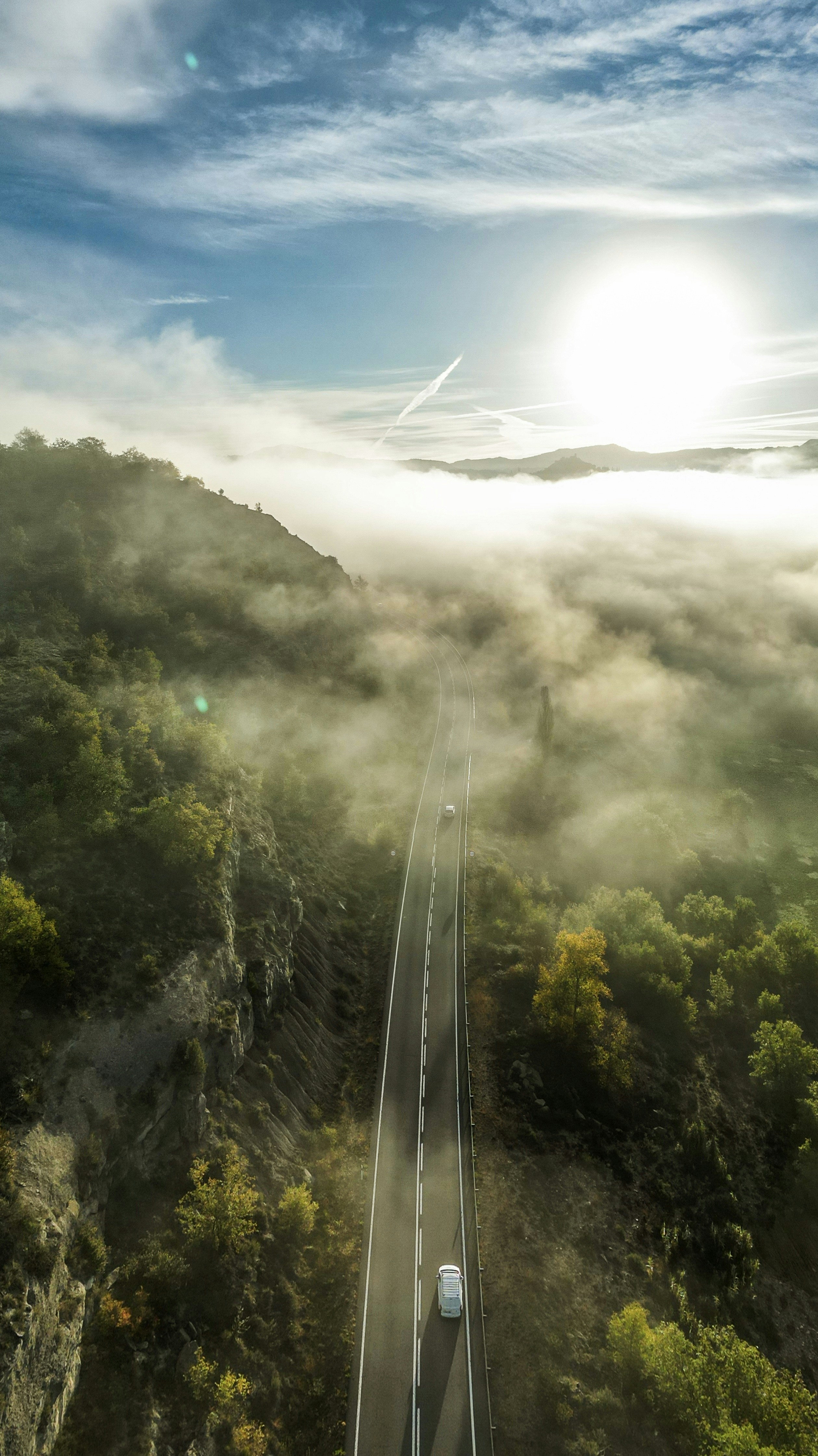 Highway through the Mist: Aerial Roadway Above the Valley