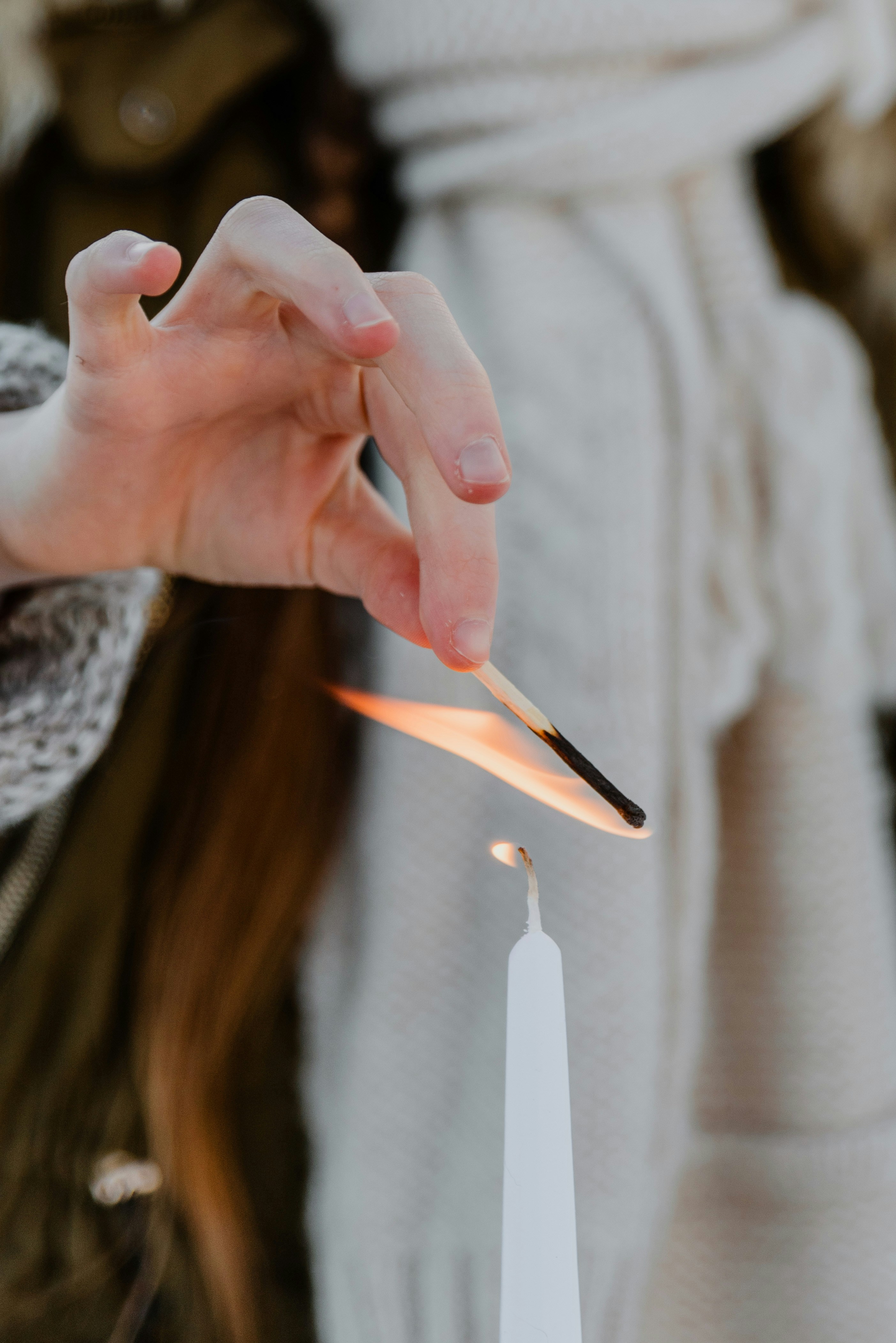 A person lighting a candle photo – Free People Image on Unsplash