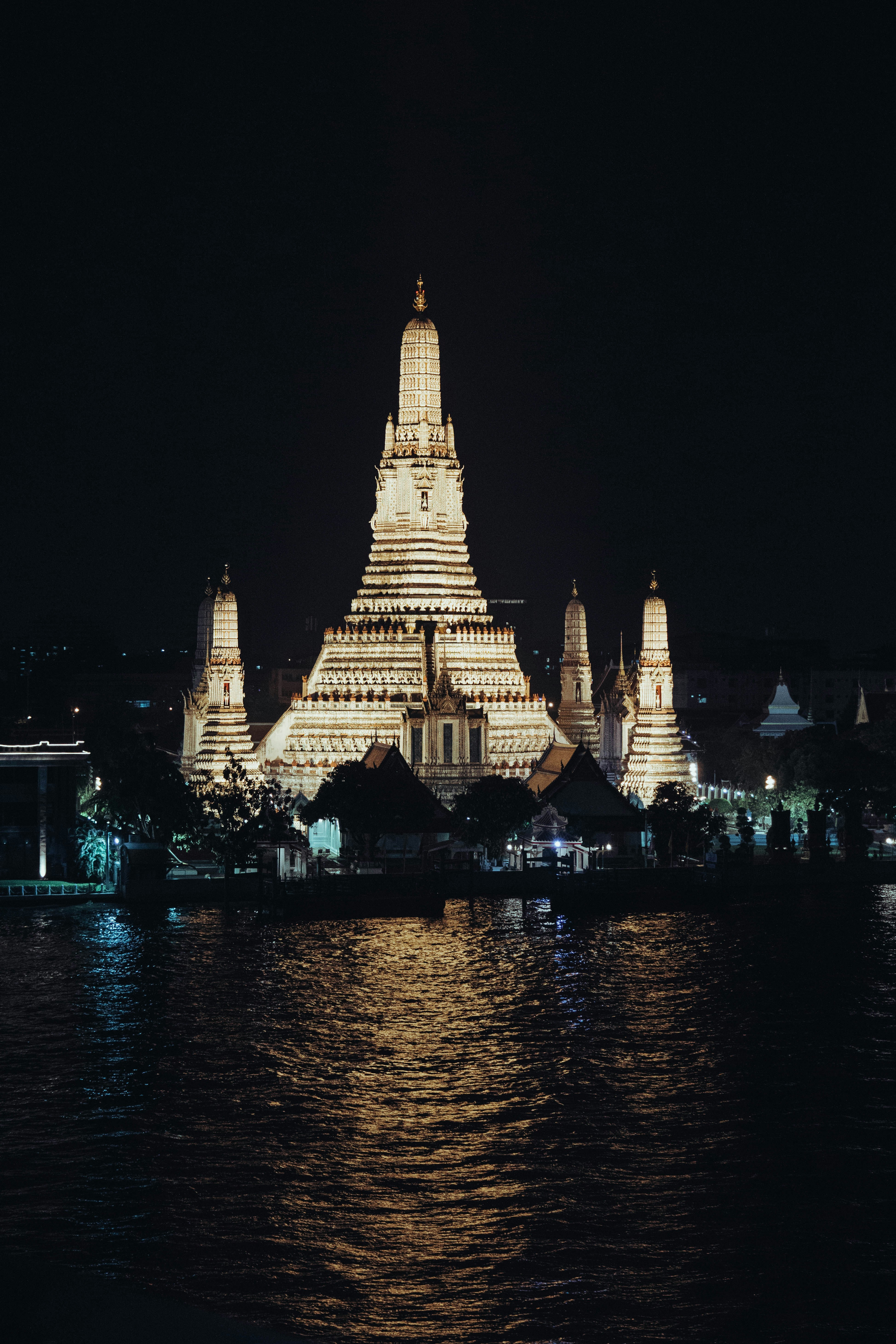 Wat Arun at Night: Illuminated Spires Rising from the Chao Phraya