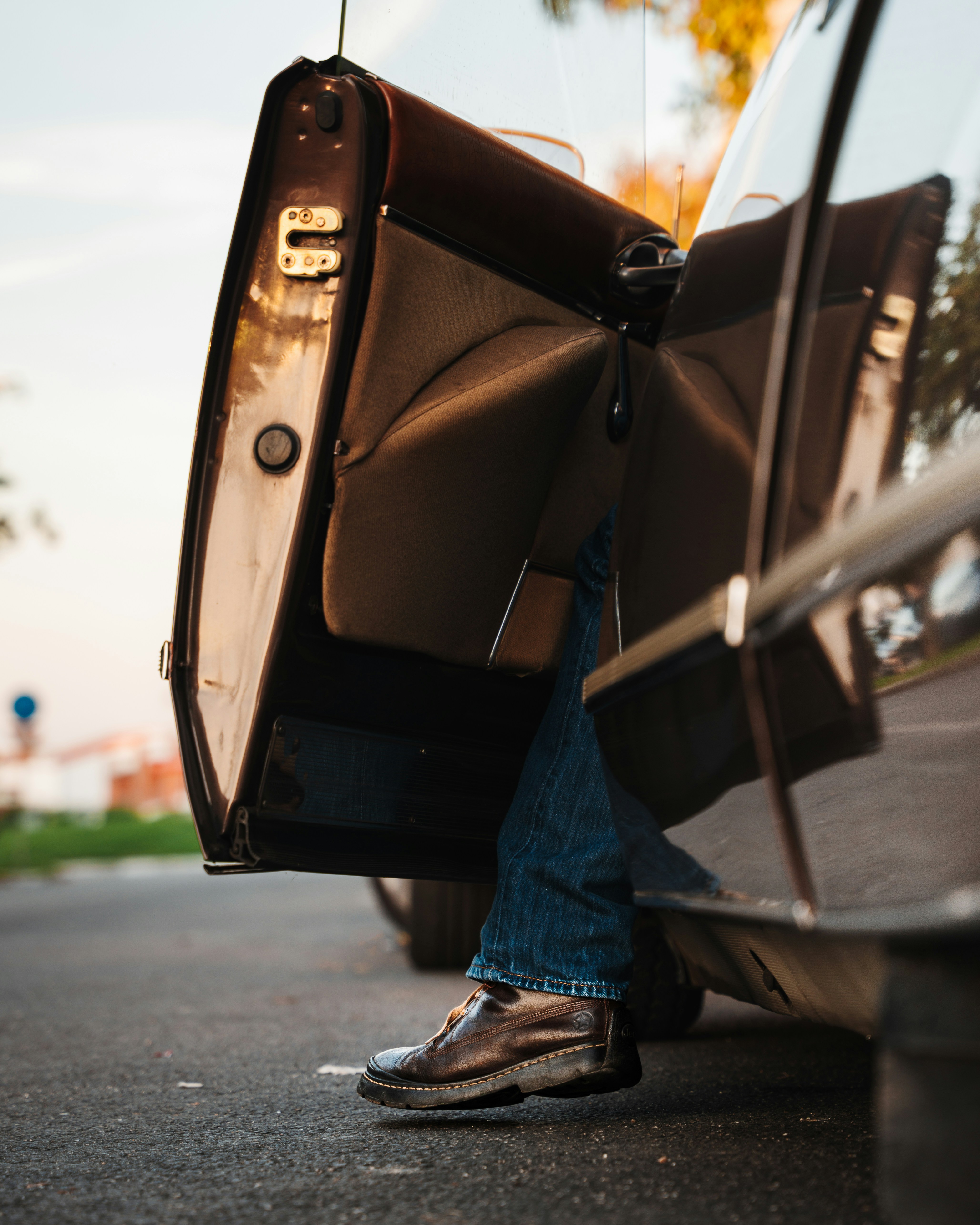 Boot on the Threshold: A Quiet Exit from a Sunlit Car