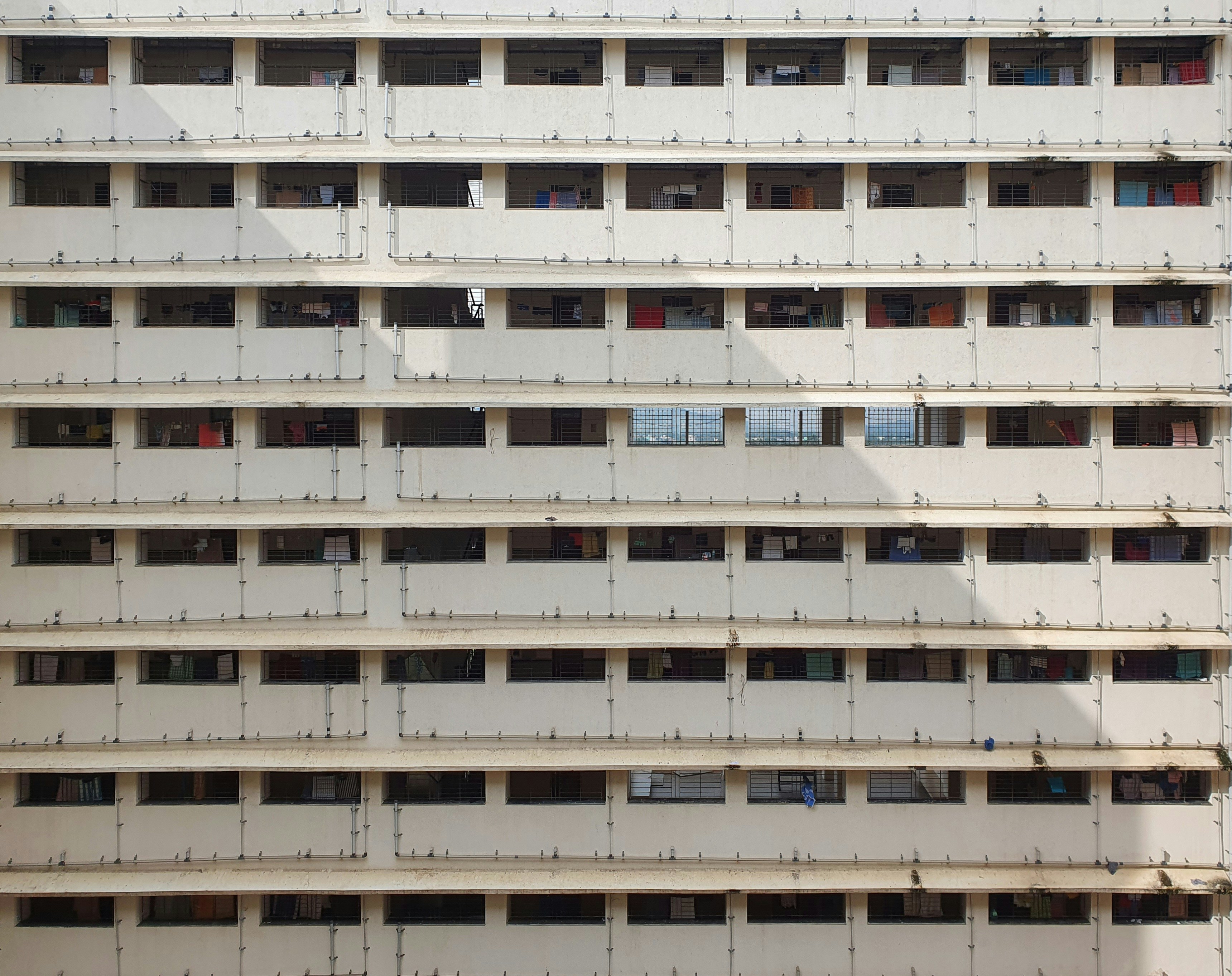 A building with many windows photo – Free Apartment building Image on ...